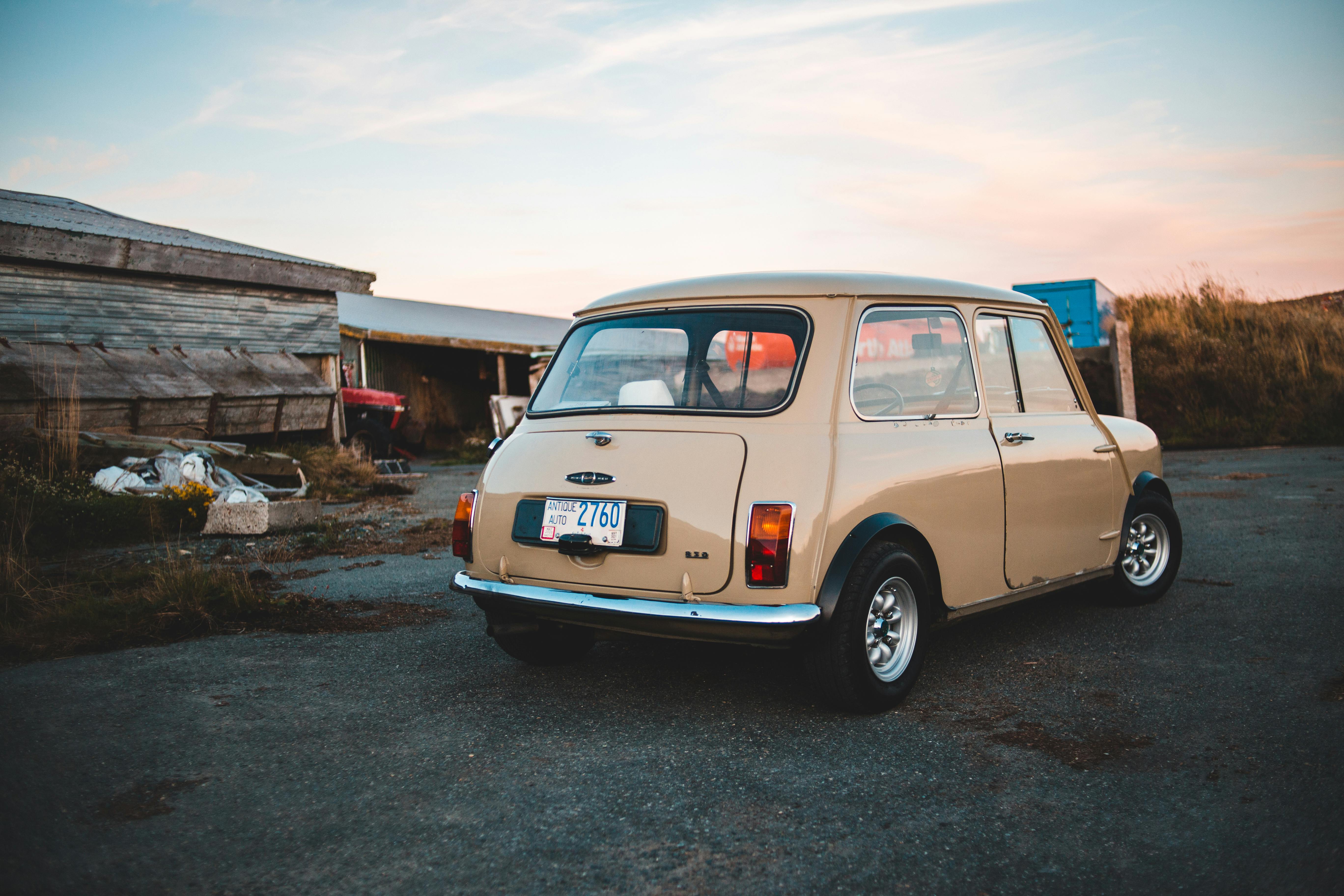 Retro car placed near wooden construction in countryside · Free Stock Photo