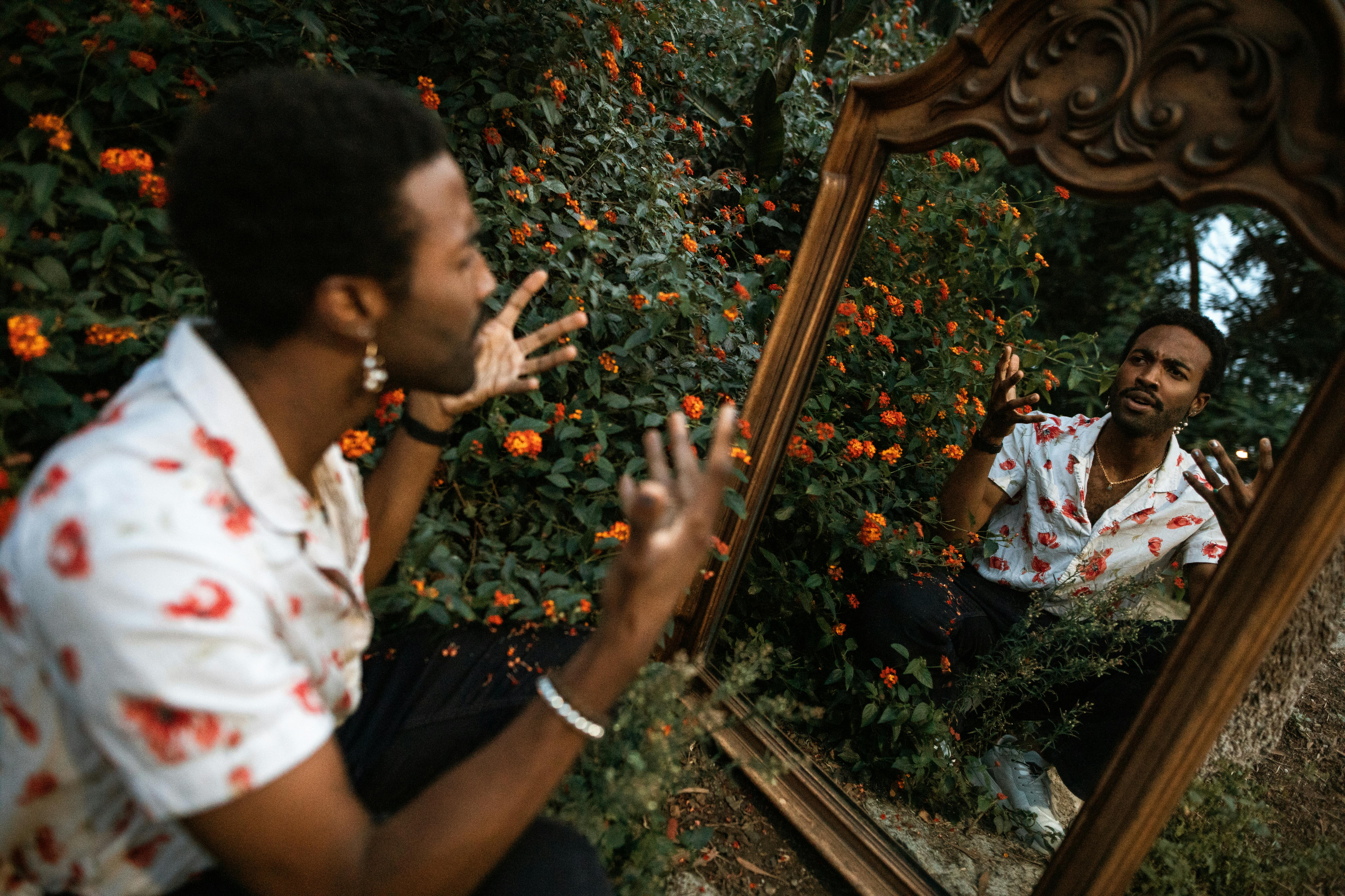 A Man Talking to Himself in the Mirror · Free Stock Photo