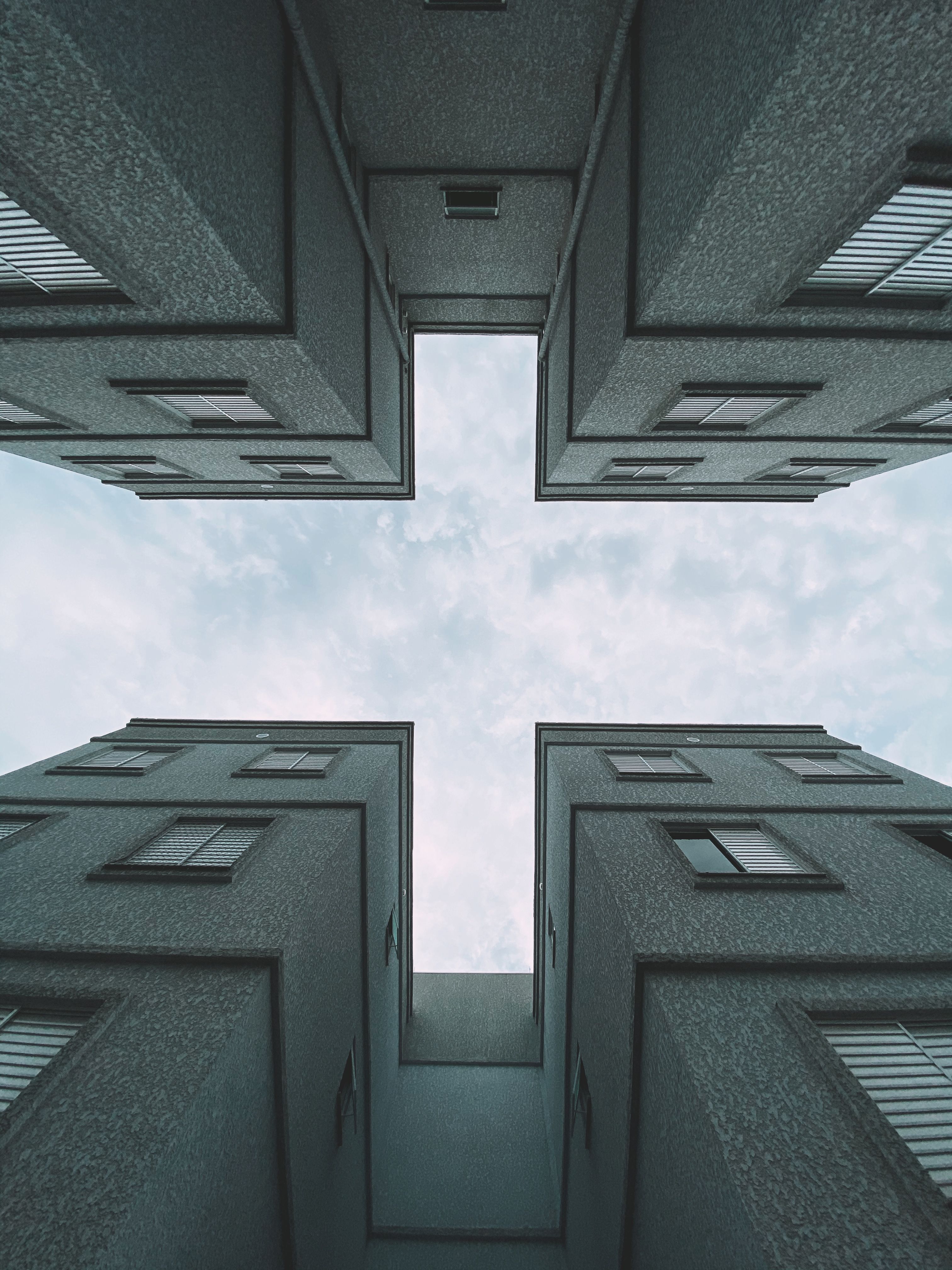 Gray Concrete Building Under White Clouds · Free Stock Photo