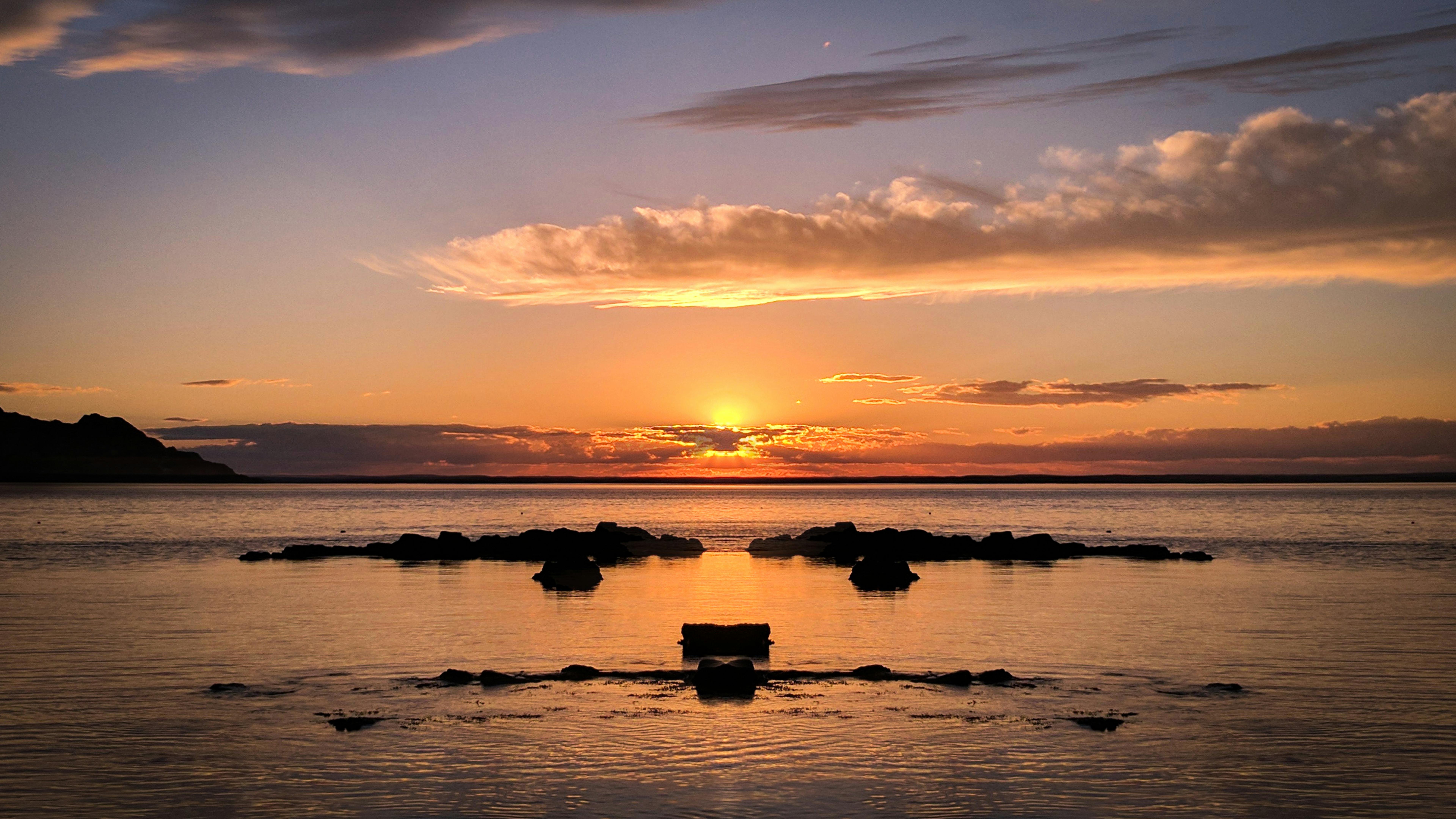 Silhouette of Rock Formation on Beach during Sunset · Free Stock Photo