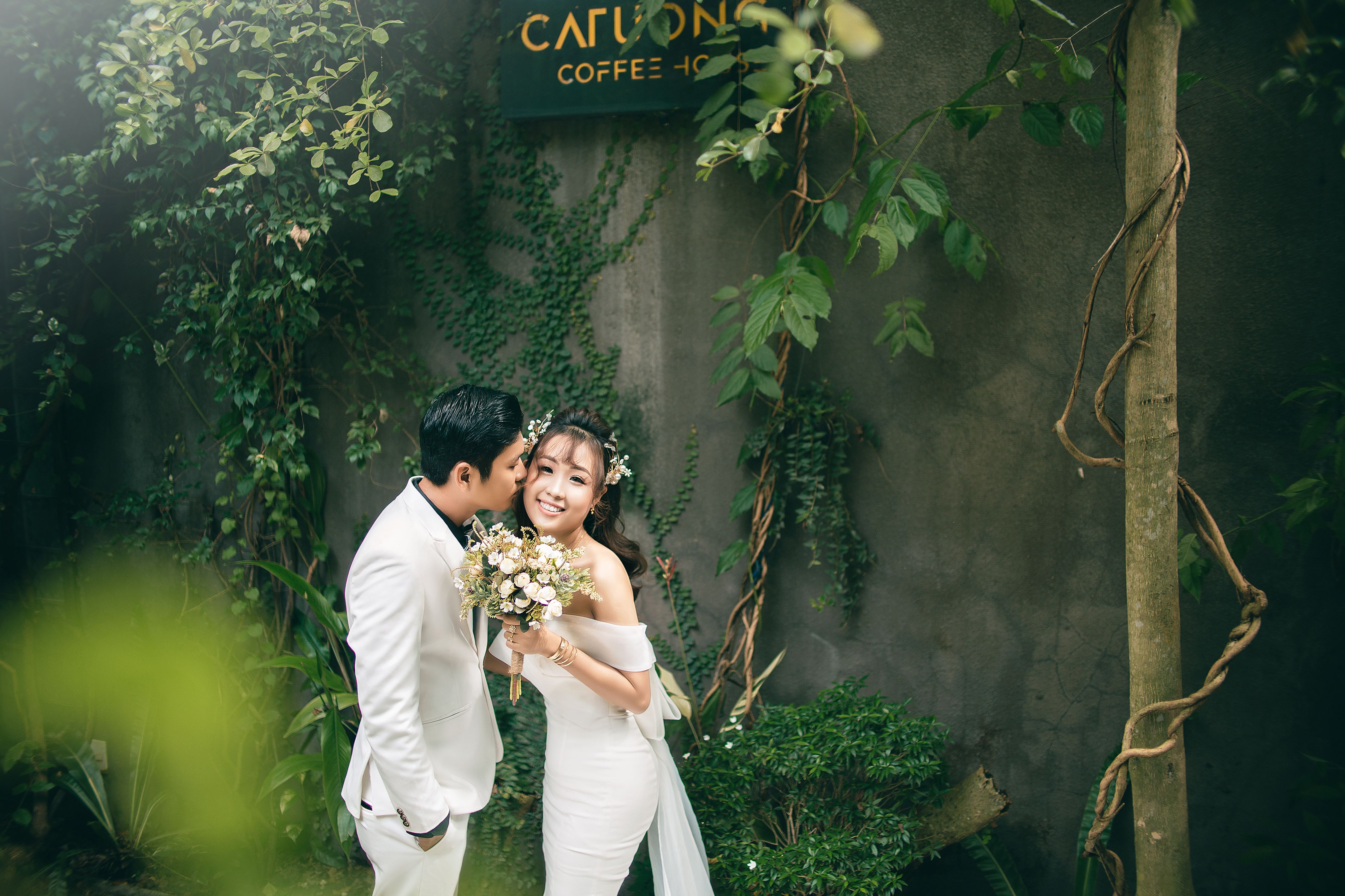 Couple Wearing Gown and Suit Jacket Standing and Pose for Picture ...