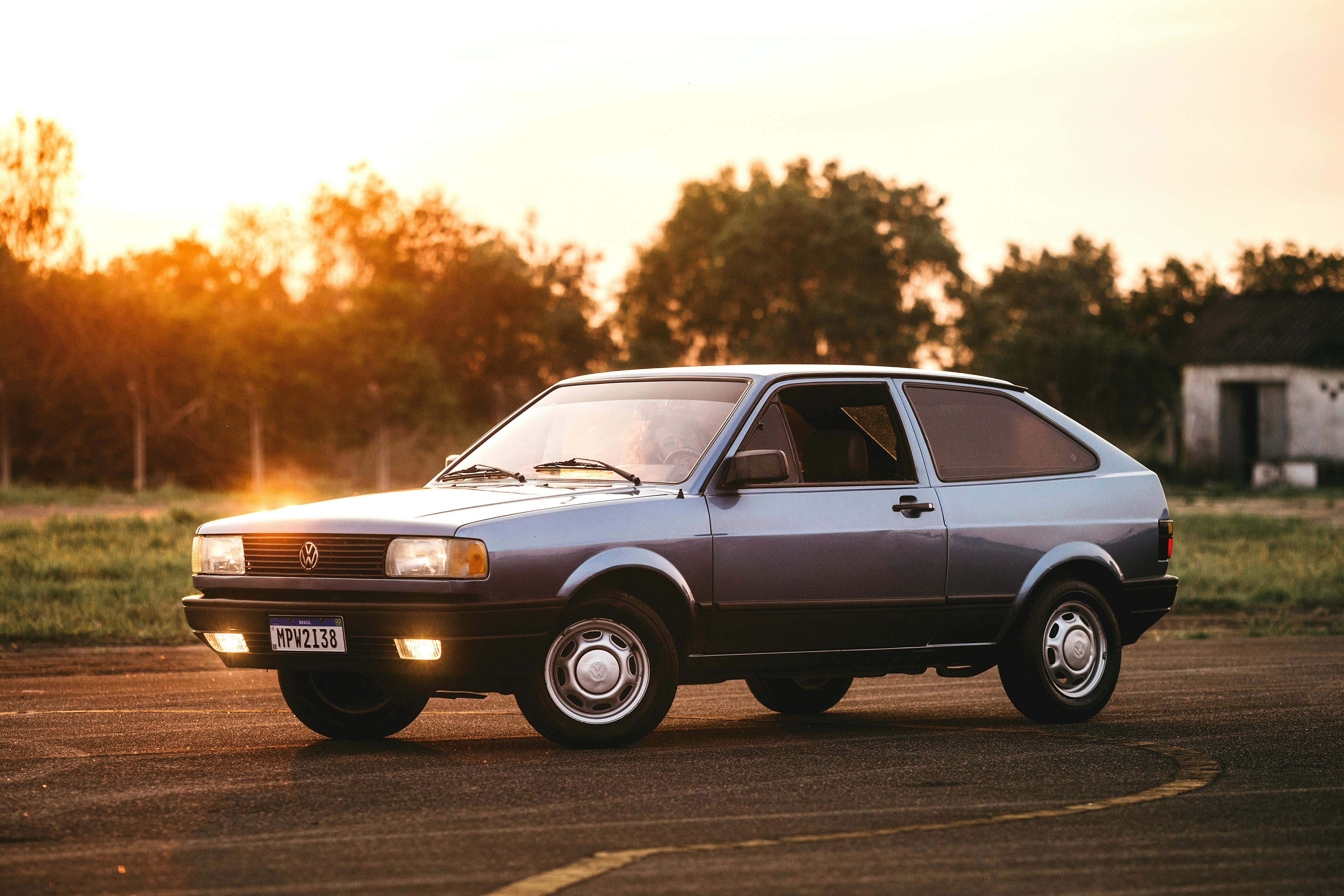 Old grey car parked on asphalt road · Free Stock Photo