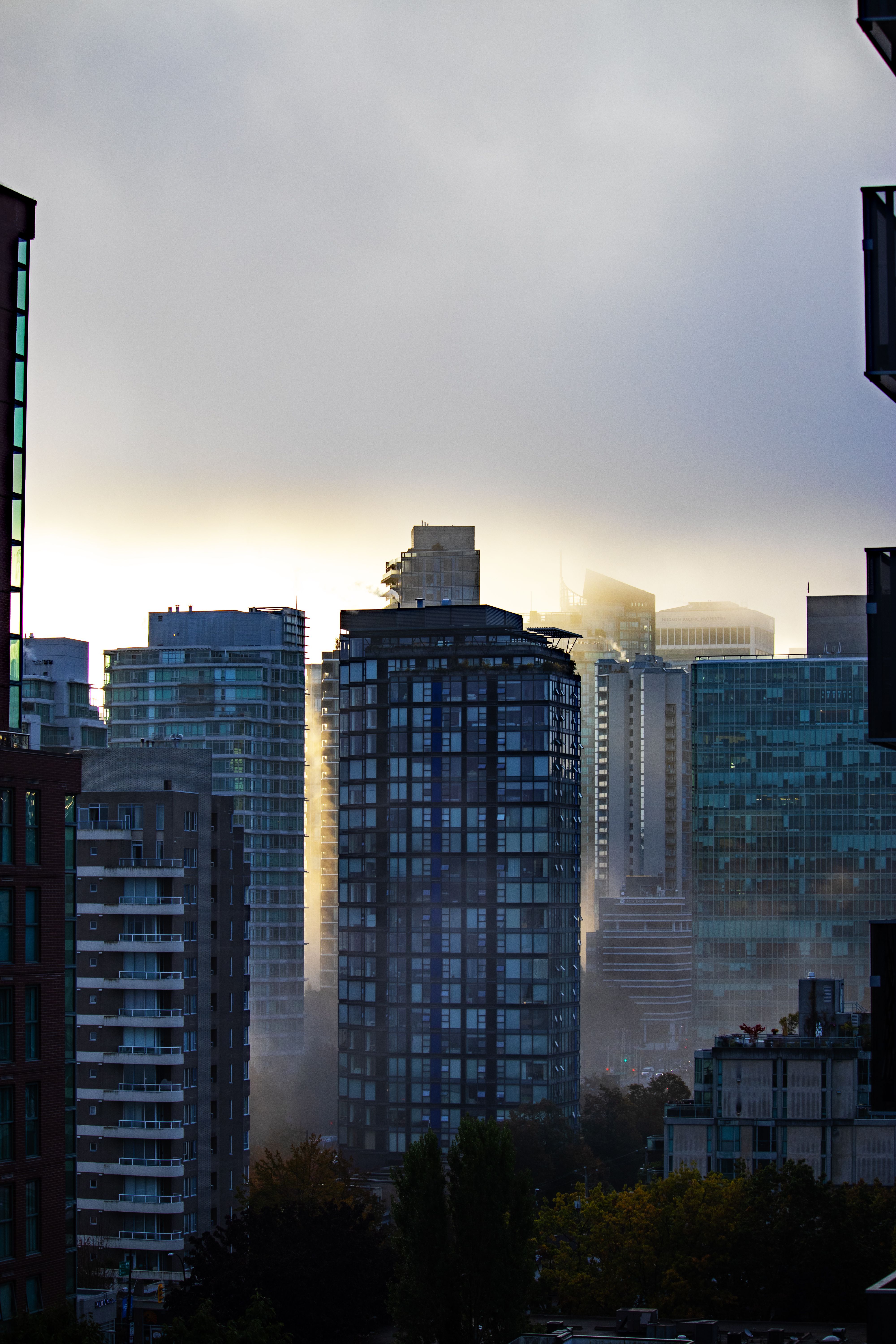 Worker in Crane Lift Ascending along Side of Building · Free Stock Photo