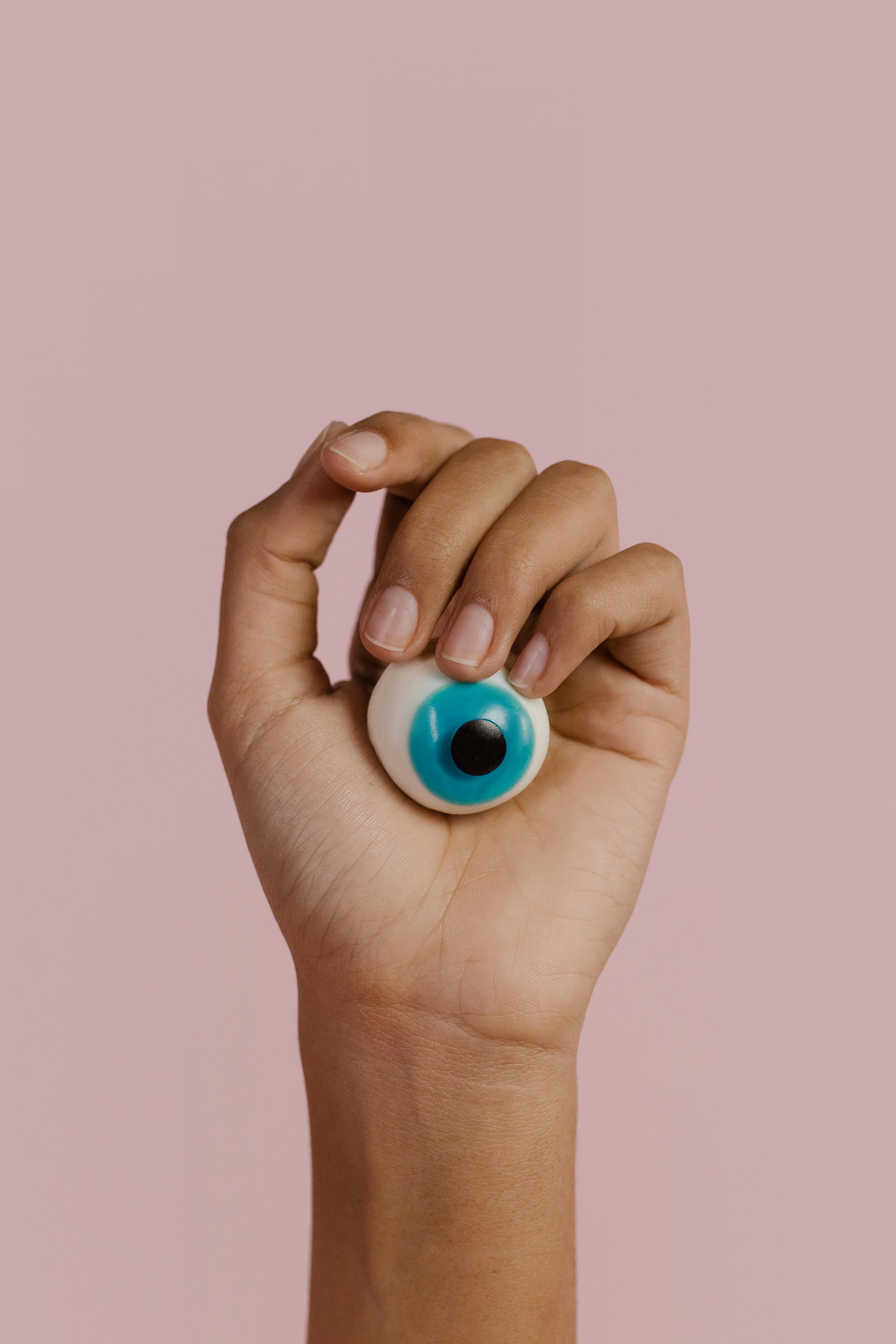 A Person Holding an Imitation Eyeball · Free Stock Photo