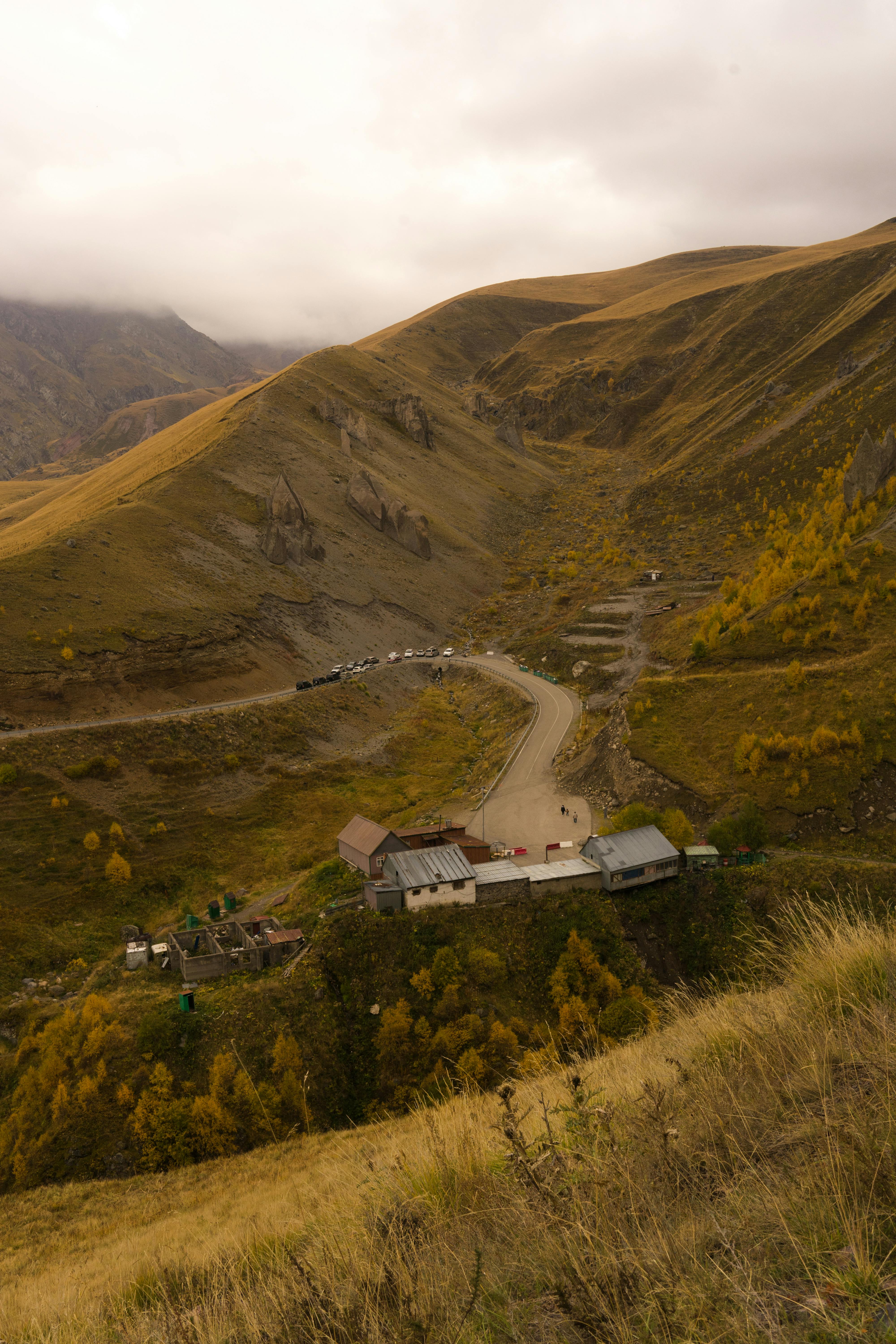 Rural buildings near road in mountains · Free Stock Photo