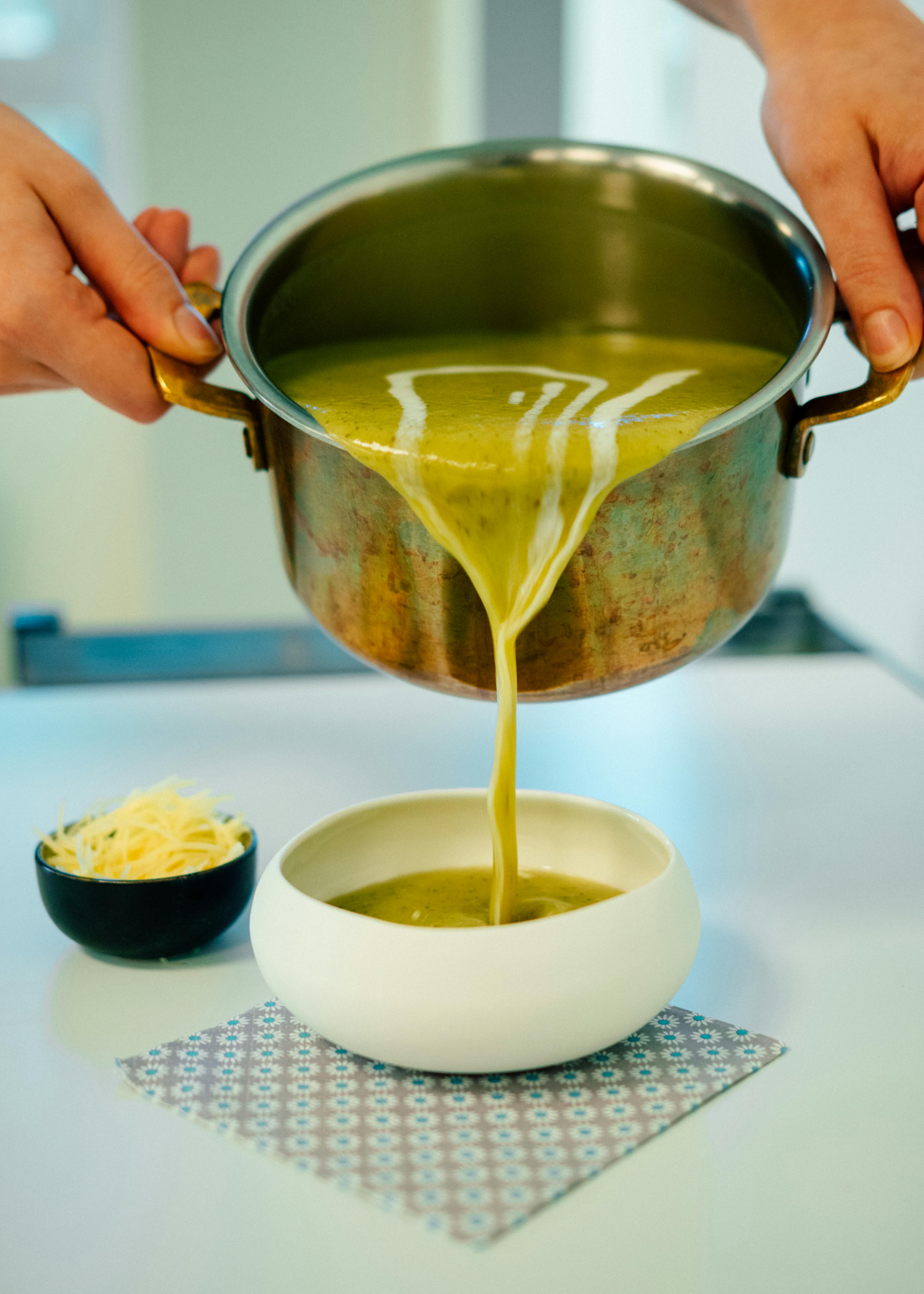 Person Pouring Soup on White Ceramic Bowl · Free Stock Photo