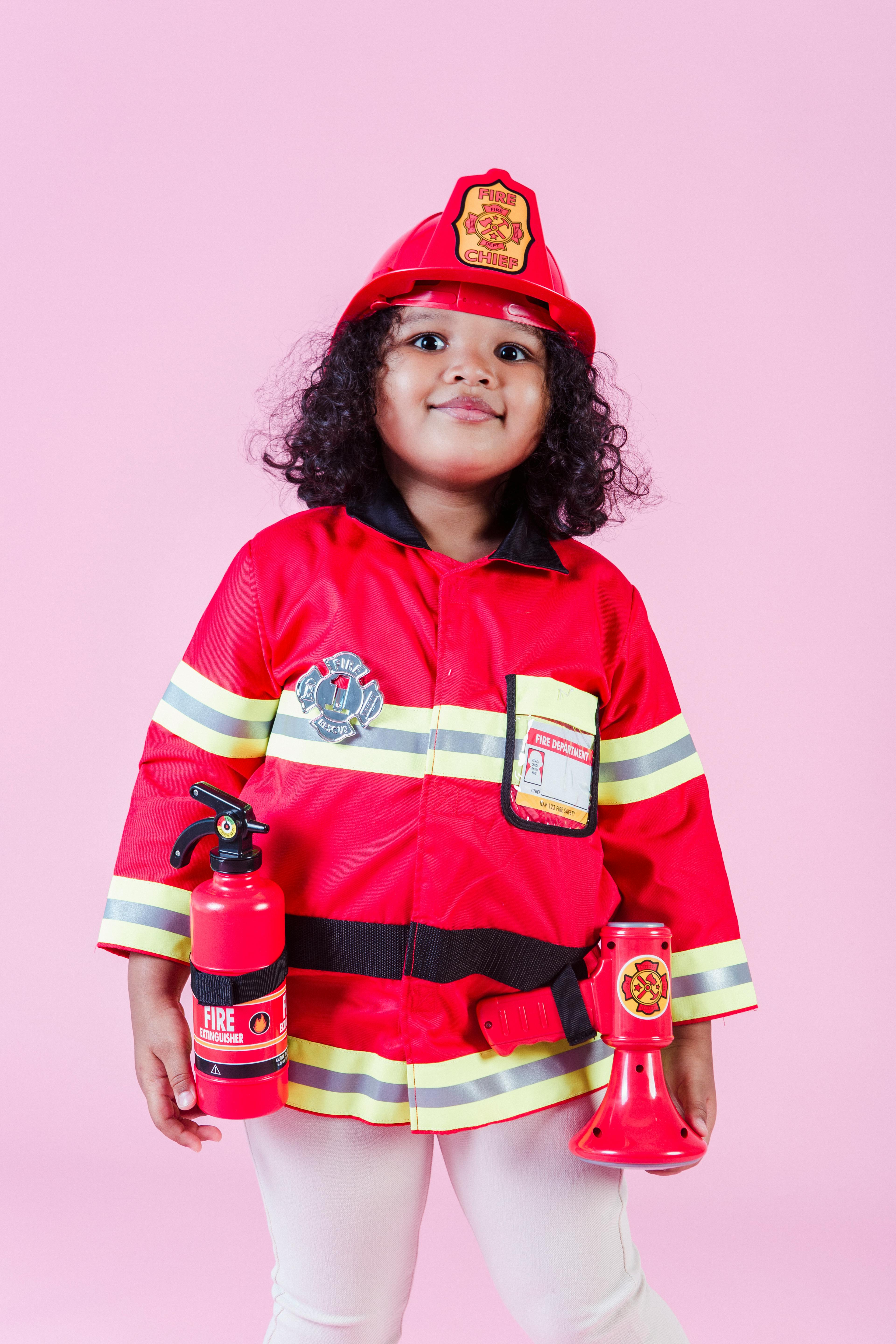 Content girl in firefighter uniform with megaphone · Free Stock Photo