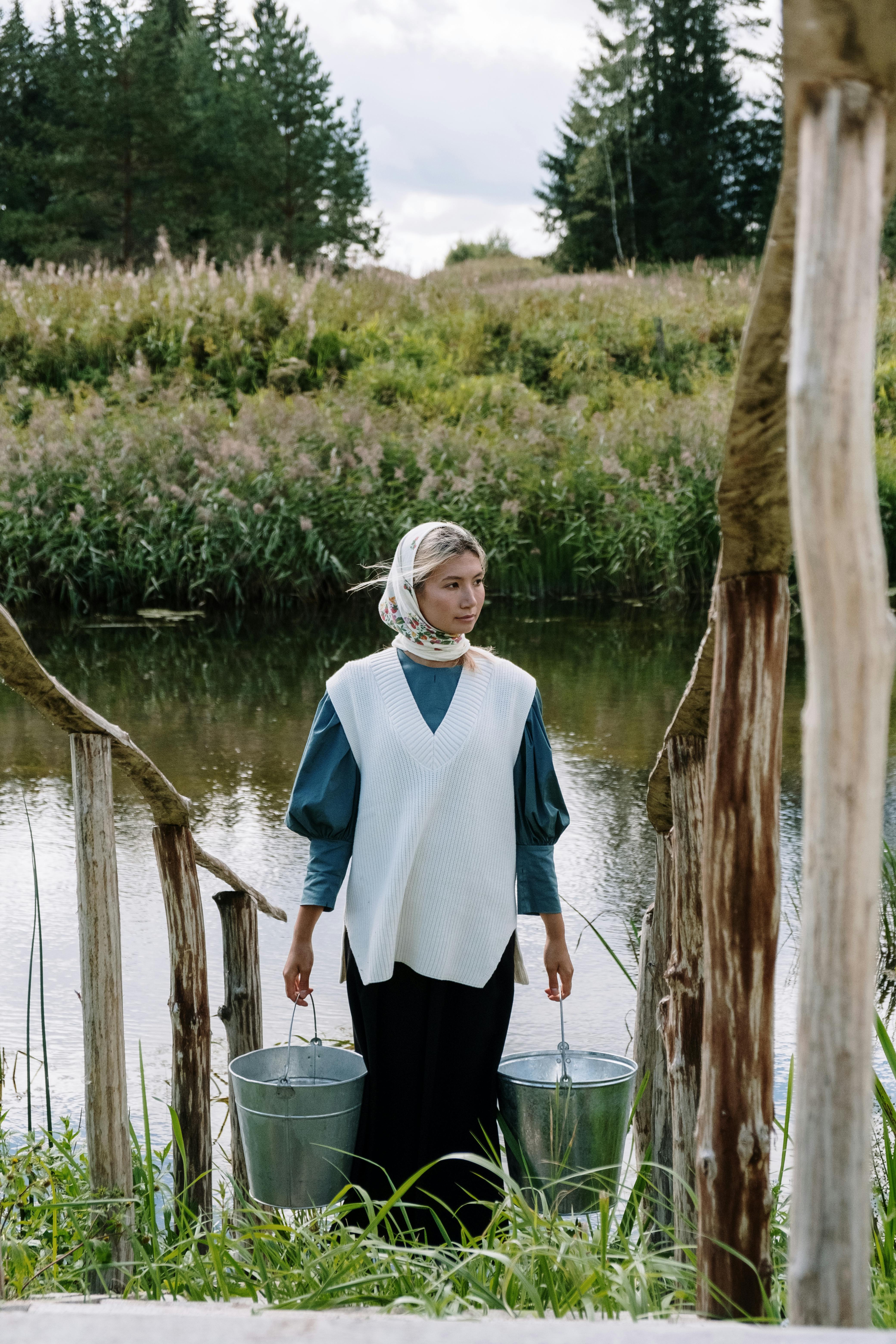 Woman Carrying Buckets of Water · Free Stock Photo