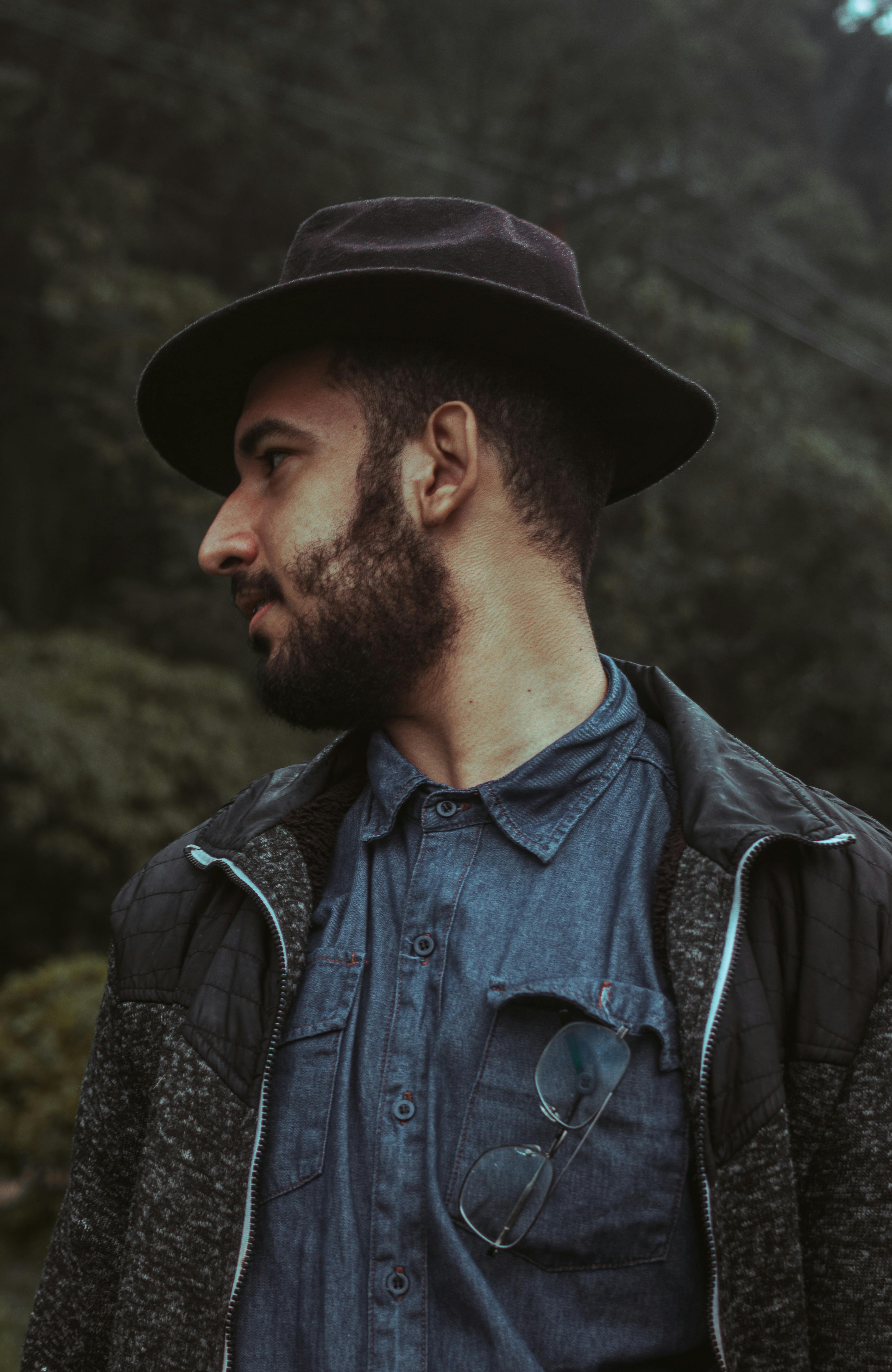 Serious anonymous man in hat near mountains · Free Stock Photo
