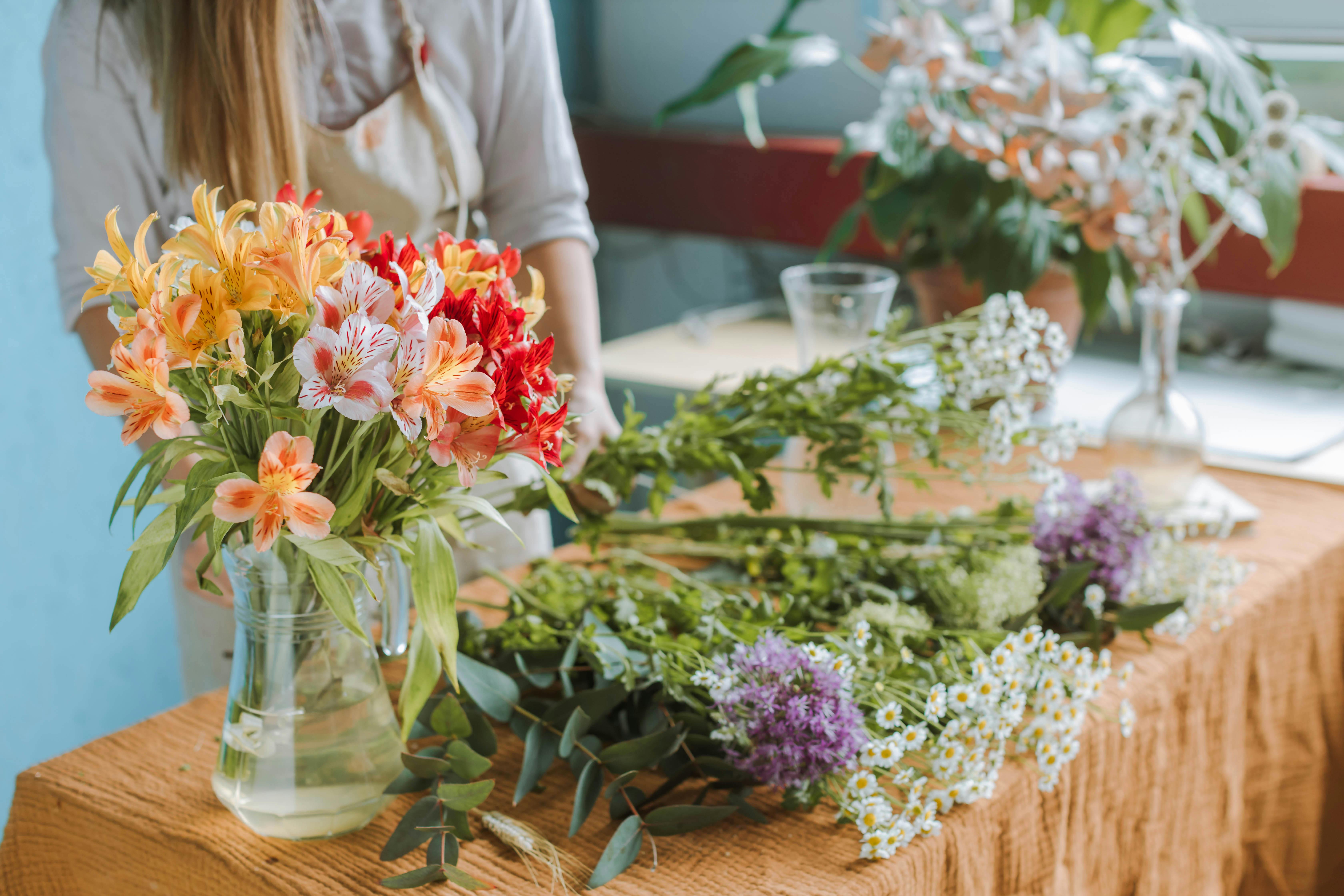 Stems of Colorful Flowers on the Table · Free Stock Photo