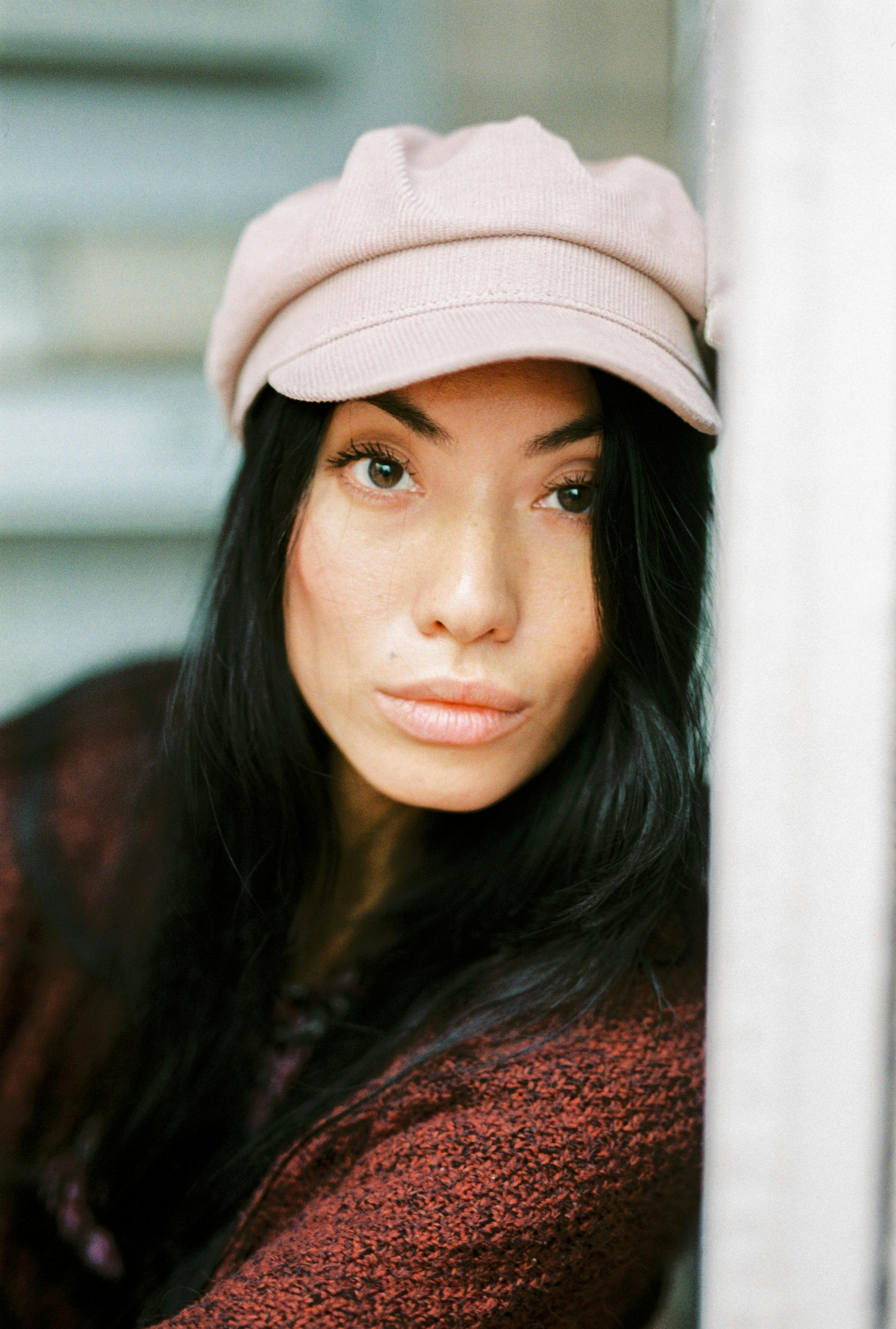 A Portrait of a Woman Wearing a Cap · Free Stock Photo