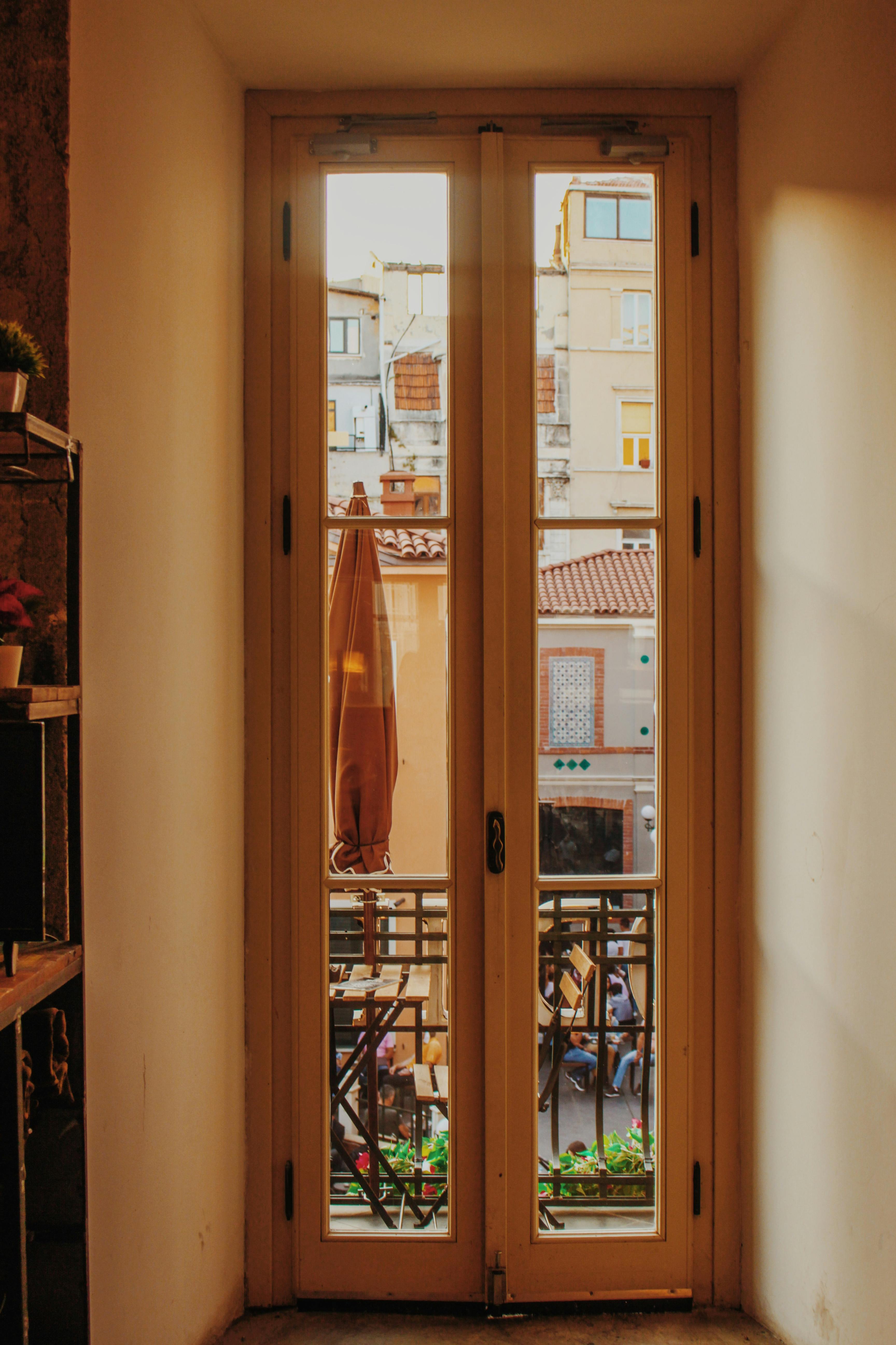 Cityscape Visible From Behind Open Balcony Door at a Waterfront House ...