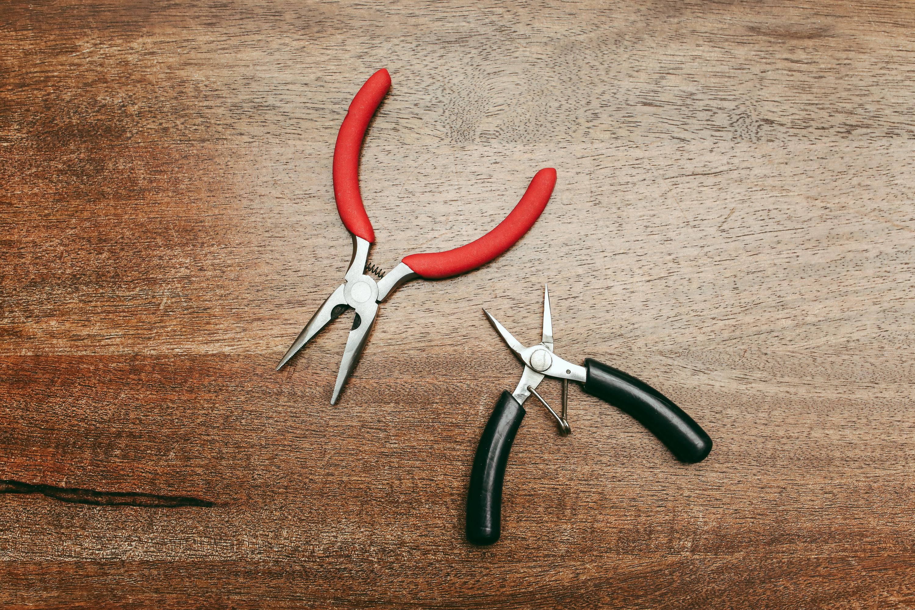 Close-Up Shot of Pliers on a Wooden Surface · Free Stock Photo