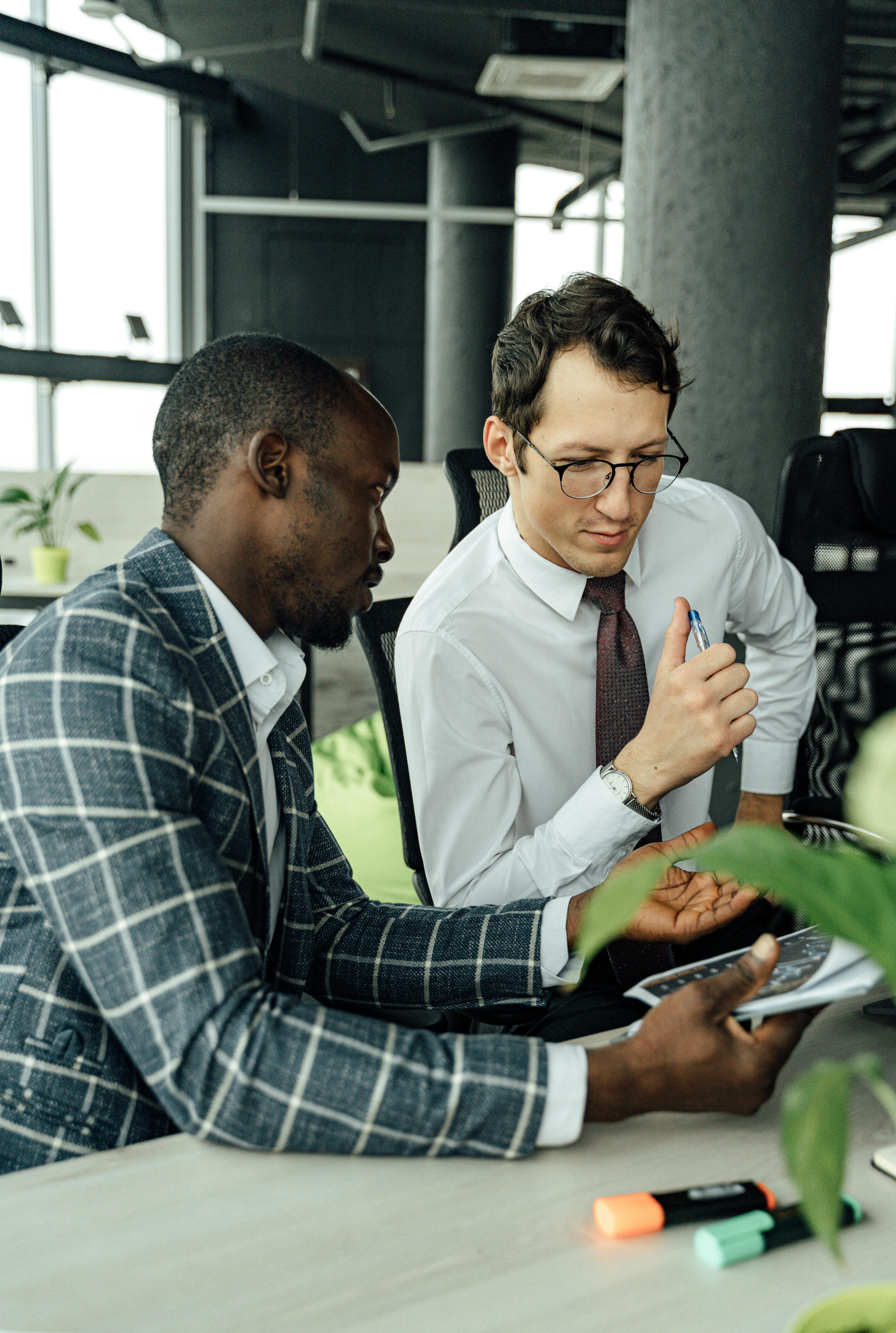 Two Men Talking Together in the Office · Free Stock Photo