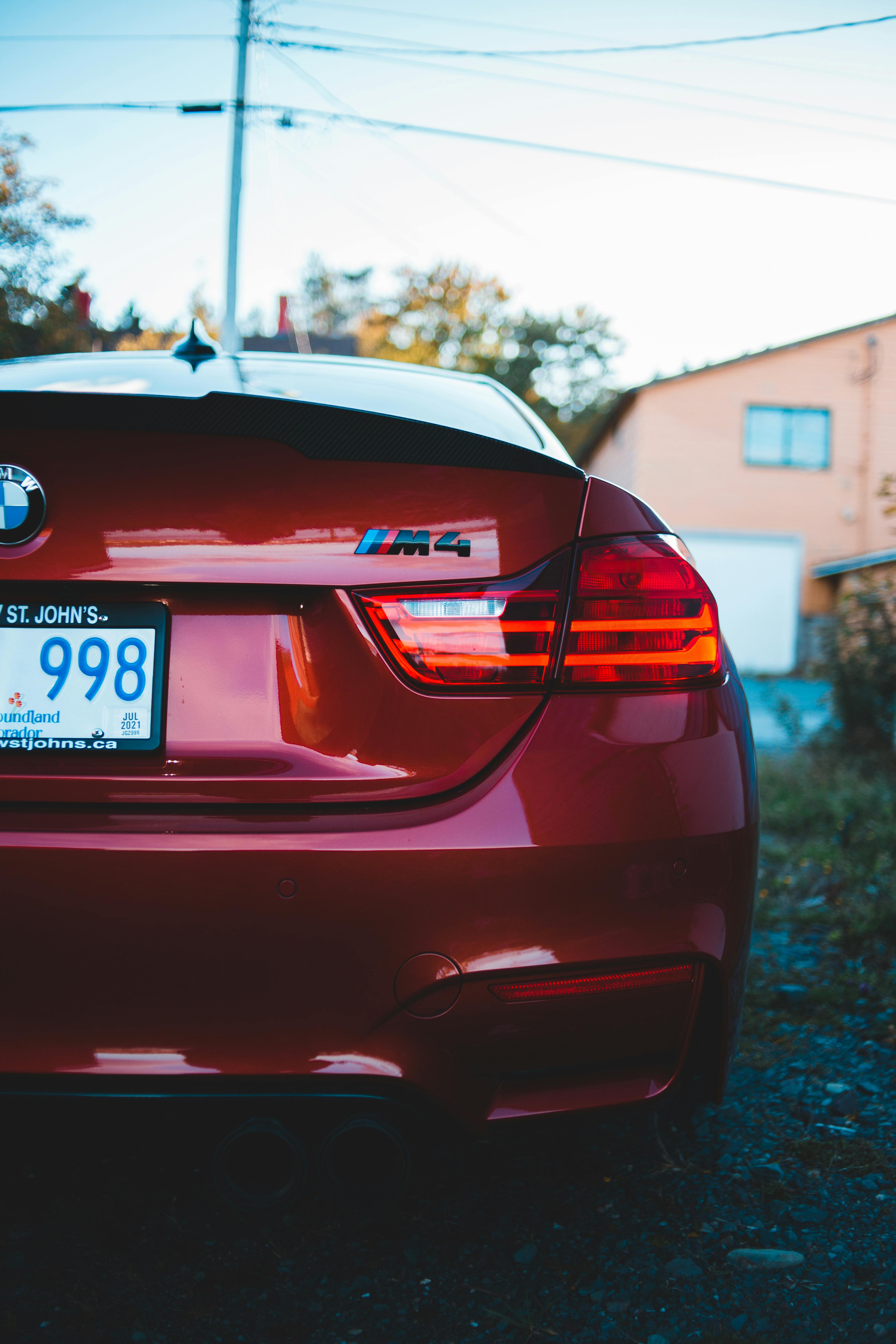 Luxury red car trunk parked on path in village · Free Stock Photo