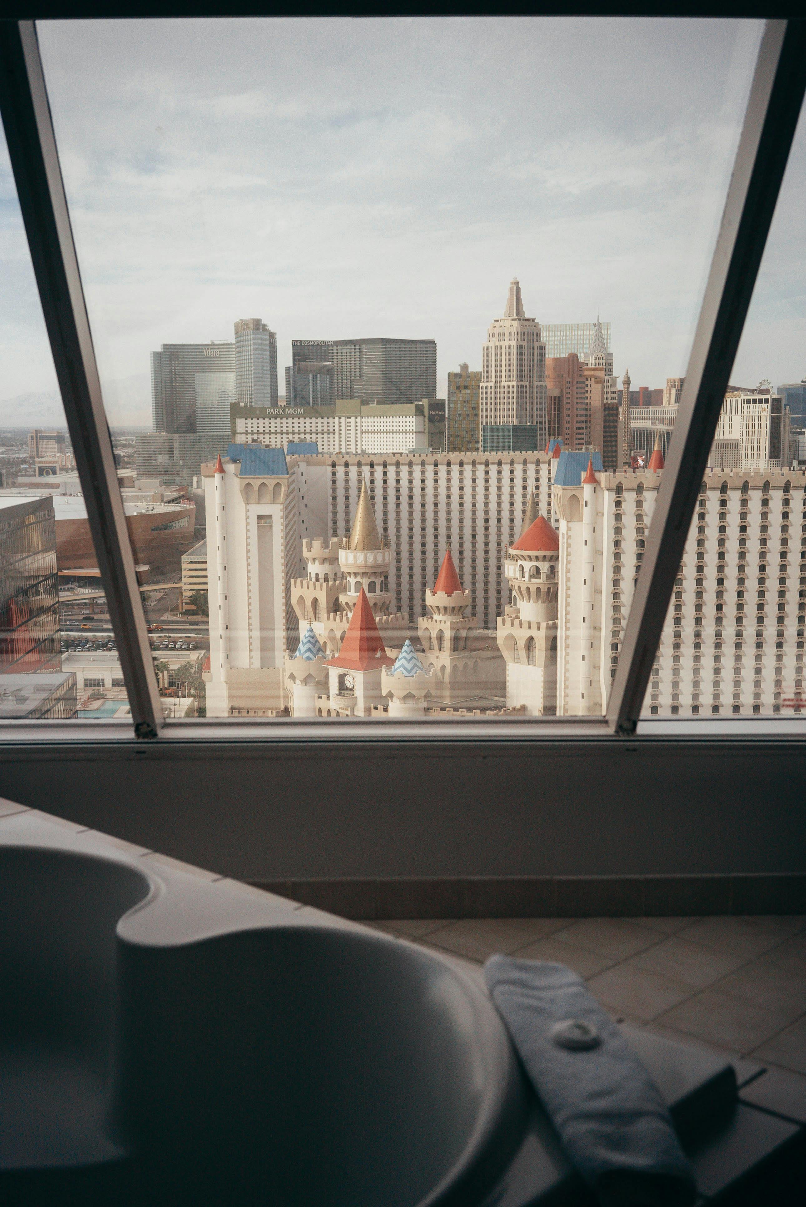 Modern city behind window in bathroom · Free Stock Photo