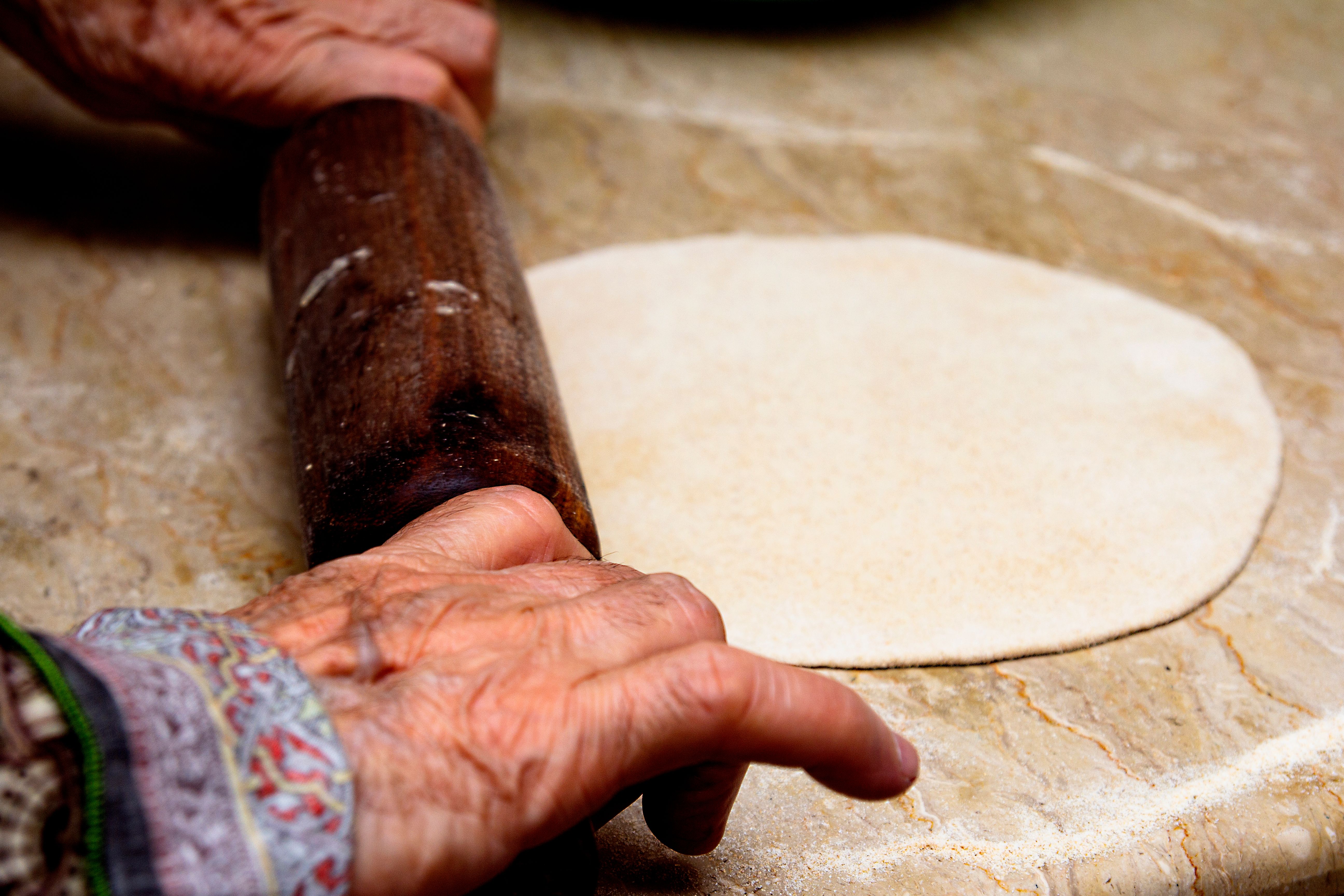 A Person Holding Brown Wooden Rolling Pin · Free Stock Photo