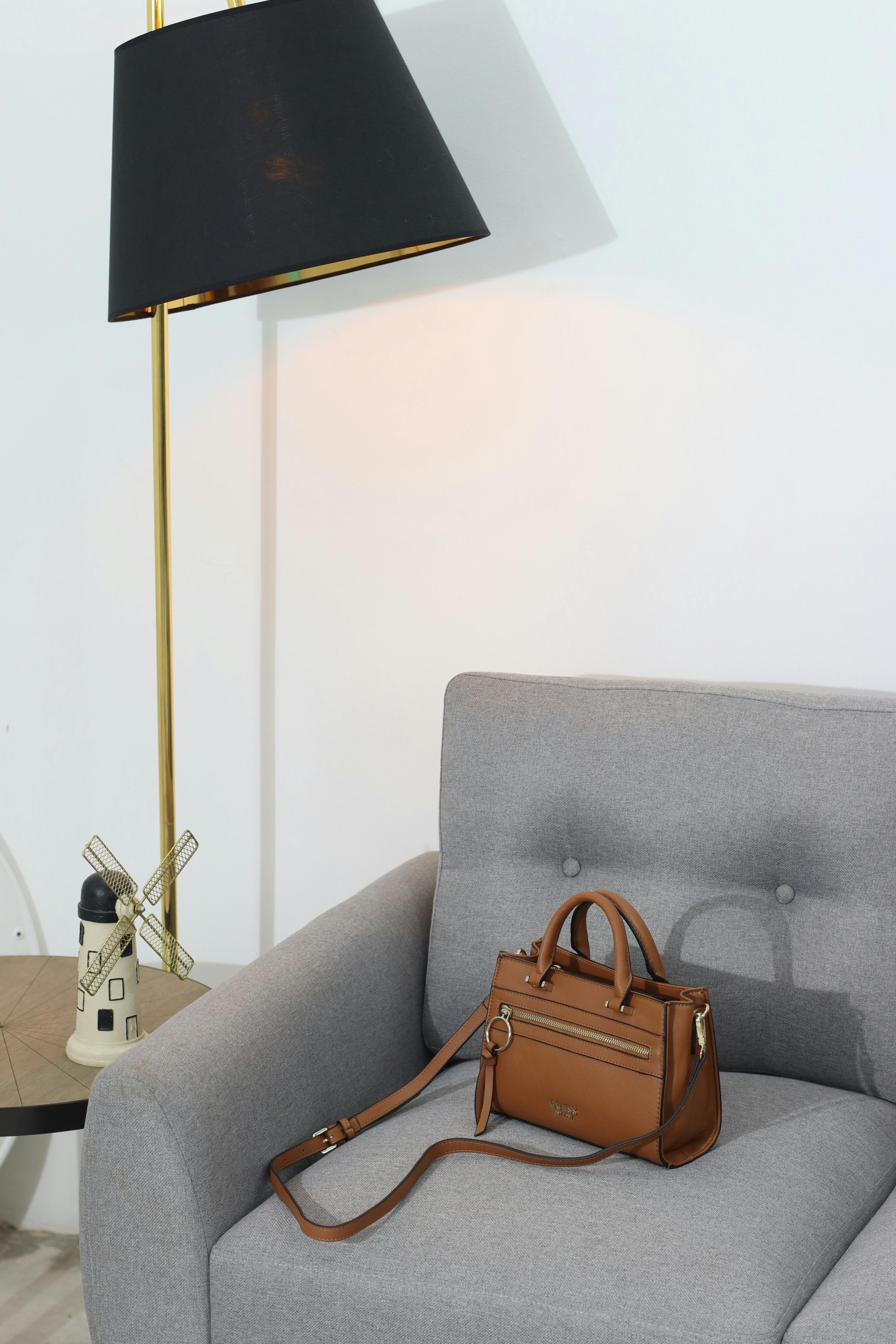 Black Leather Bag on White Sofa · Free Stock Photo