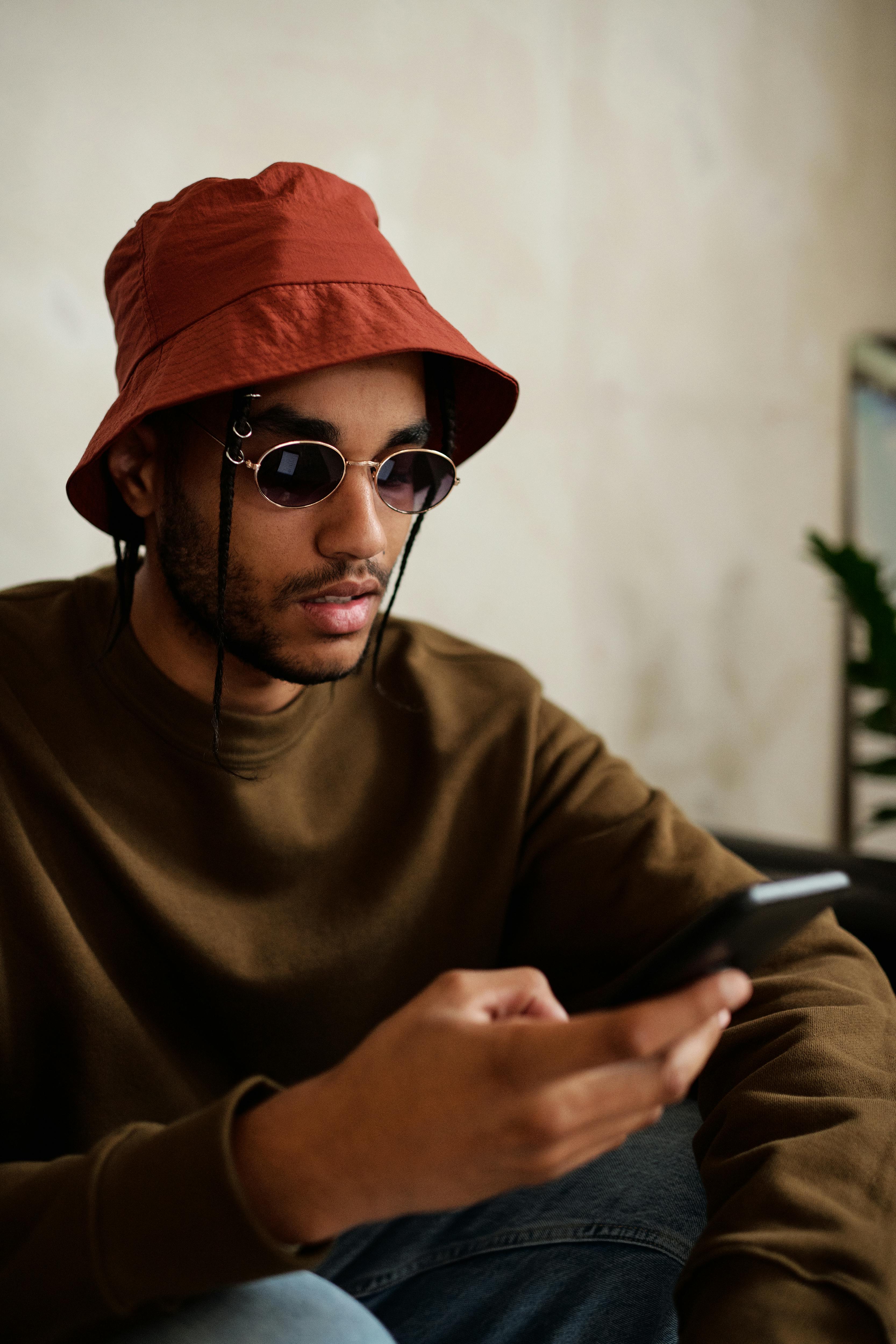 A Man in a Sweater Using His Smartphone · Free Stock Photo