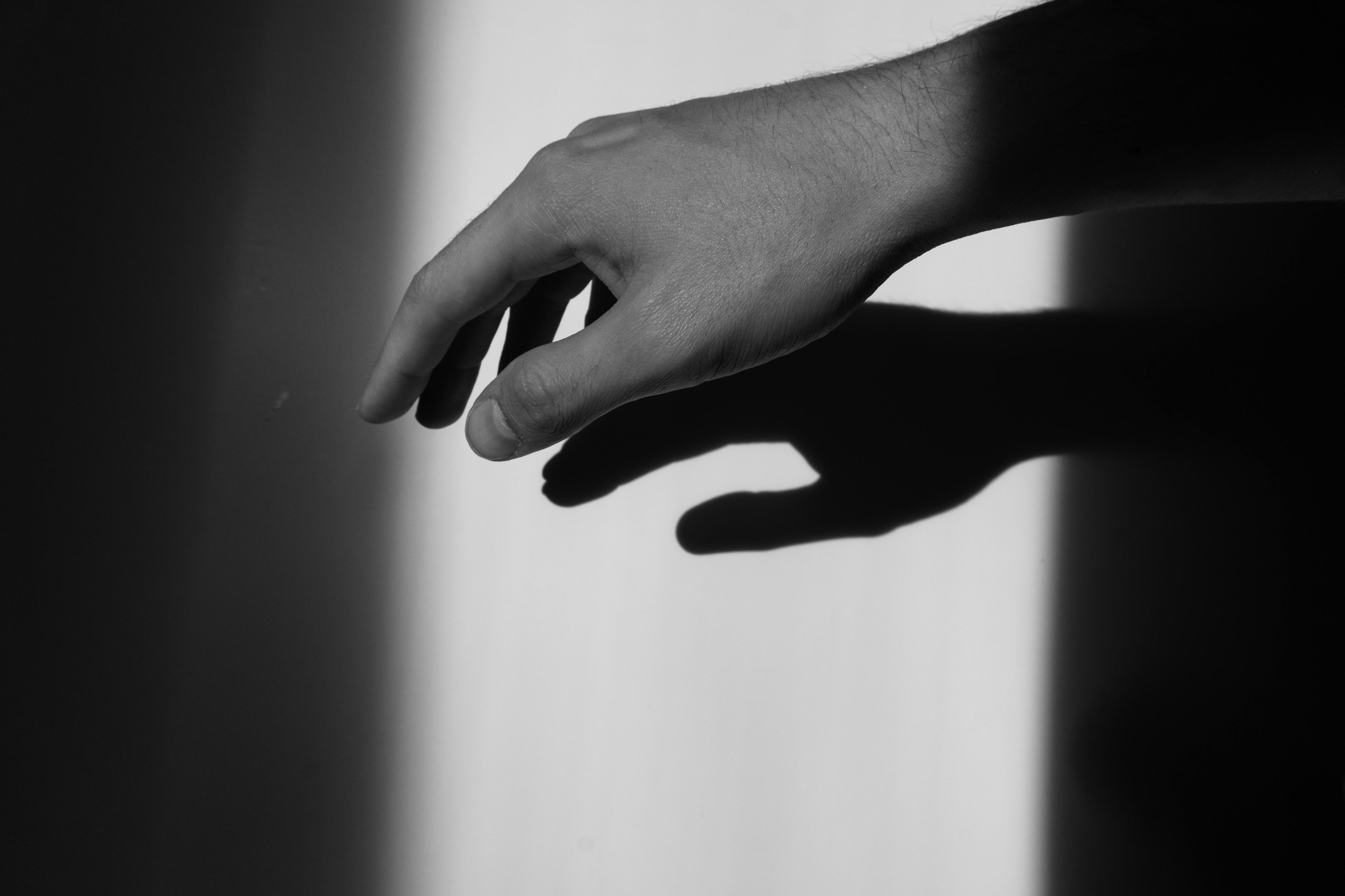 Grayscale Photo of Hands Floating on Water · Free Stock Photo