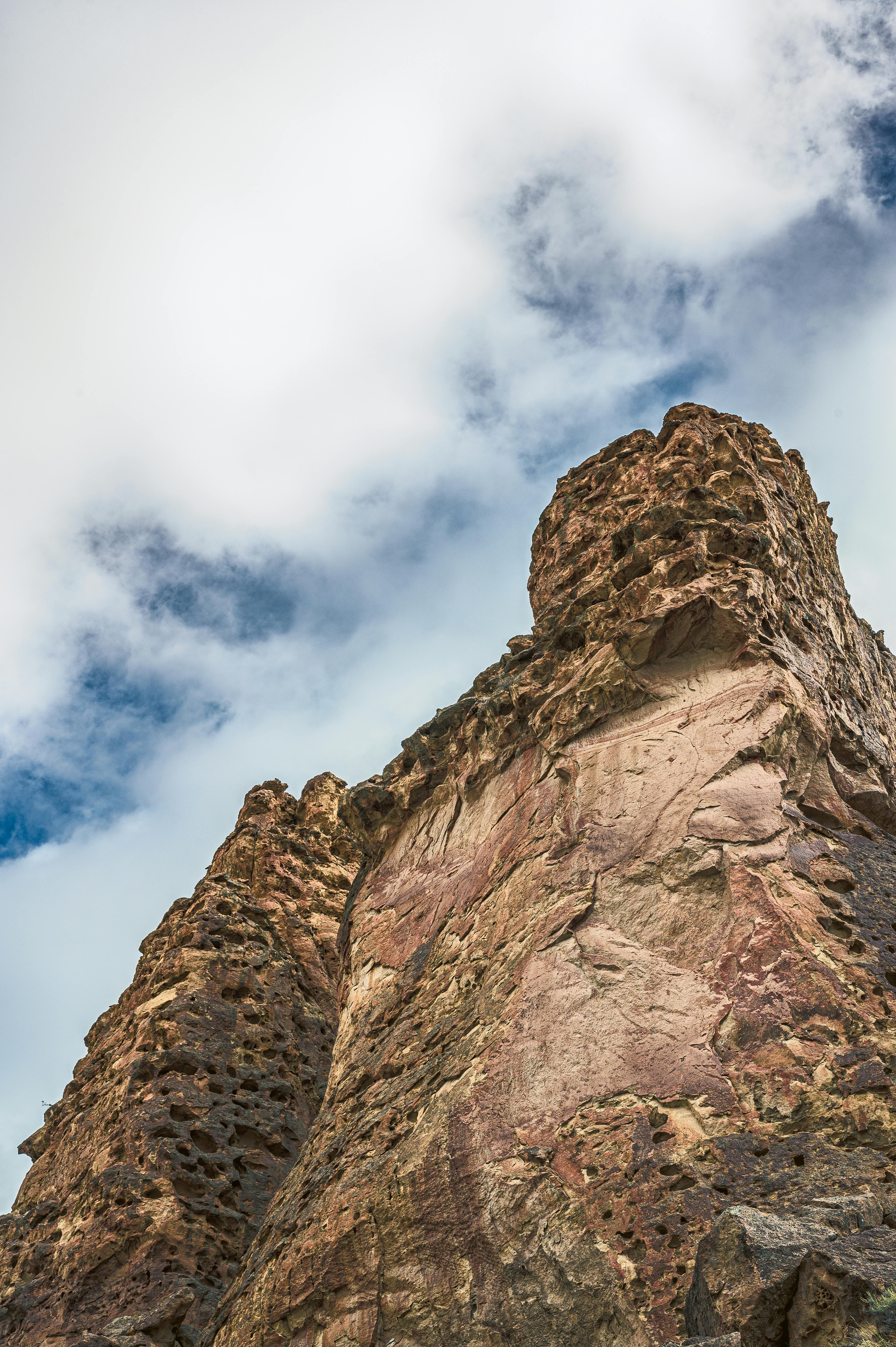 Rough rocky cliff with cracks and holes · Free Stock Photo