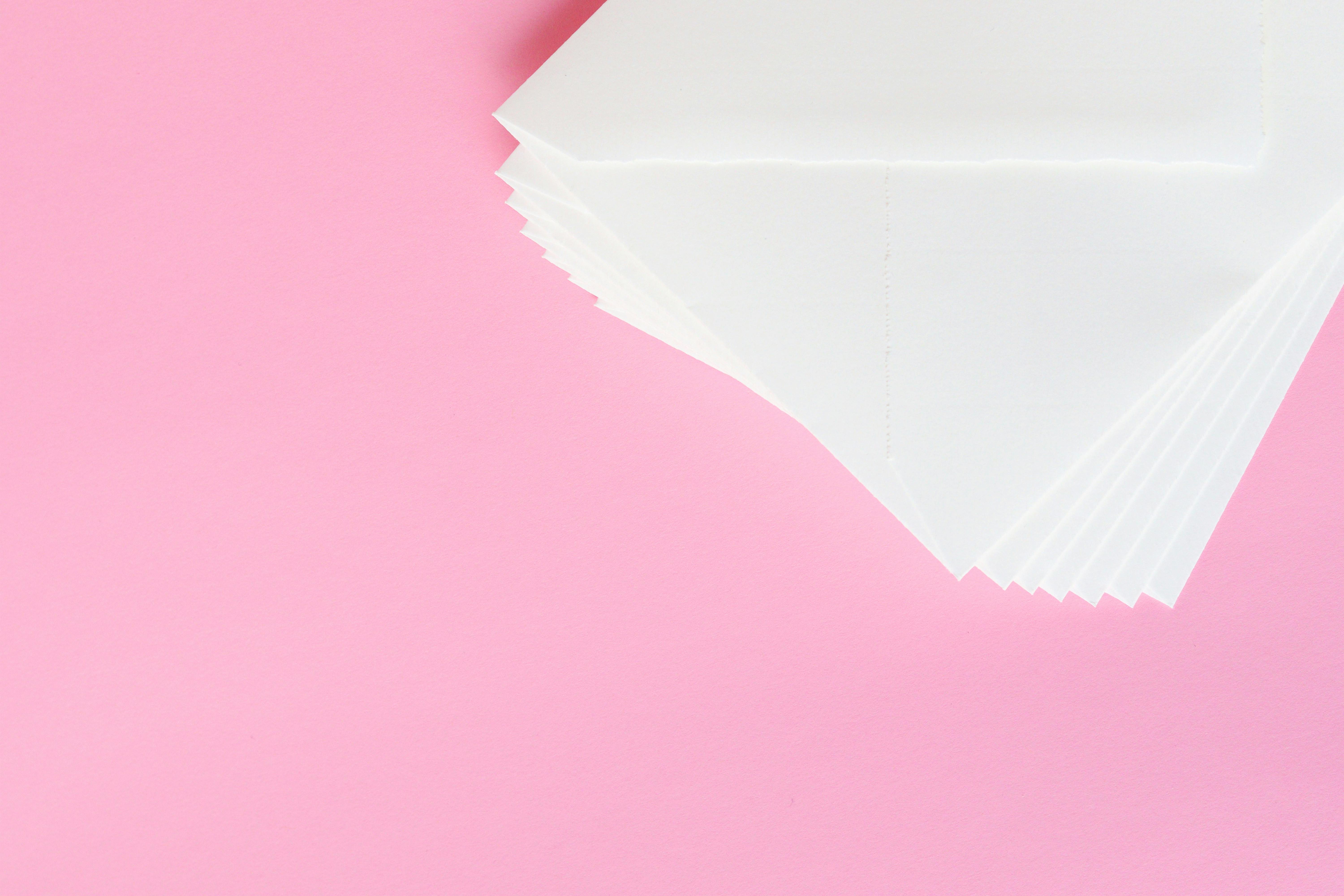 White Paper on Pink Surface · Free Stock Photo
