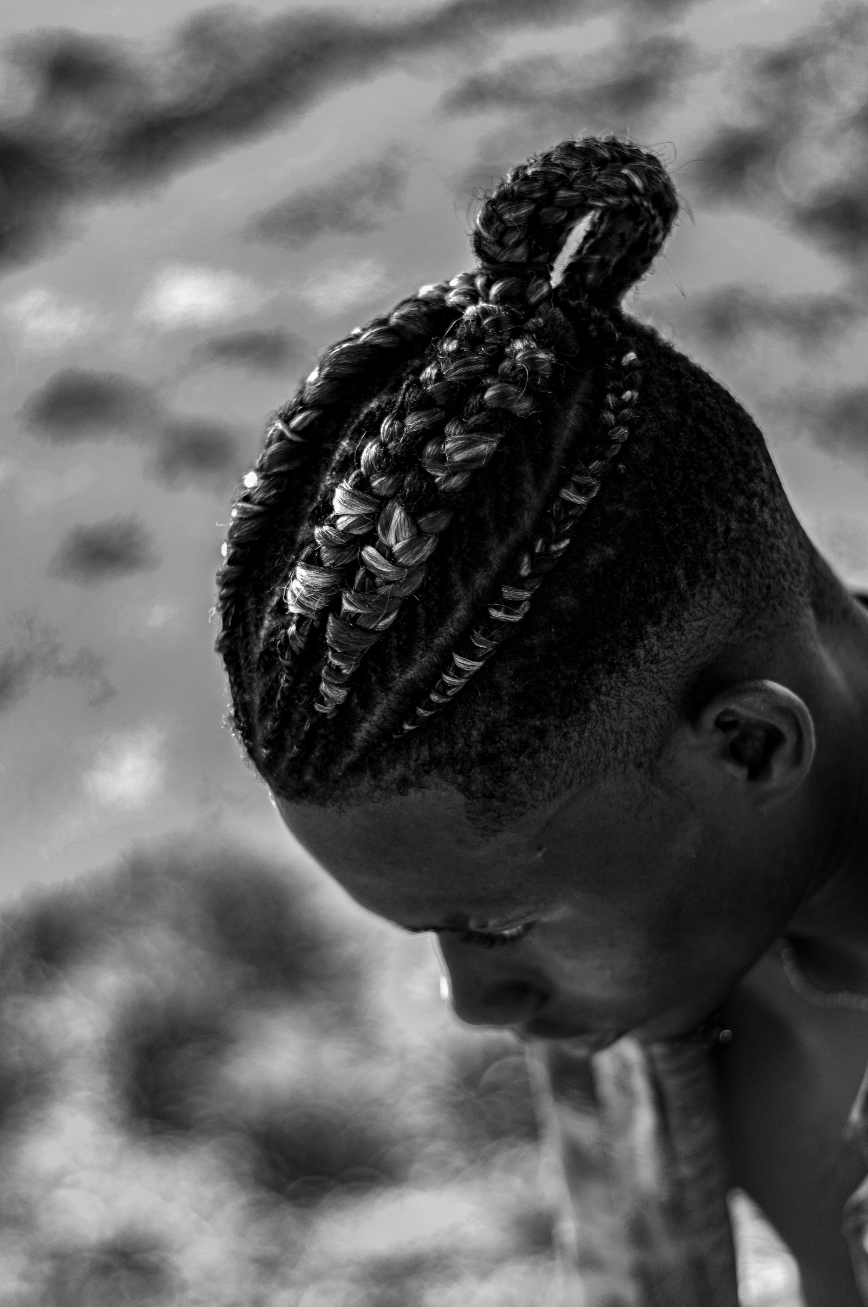 Crop faceless ethnic person touching ponytail of African braids · Free ...