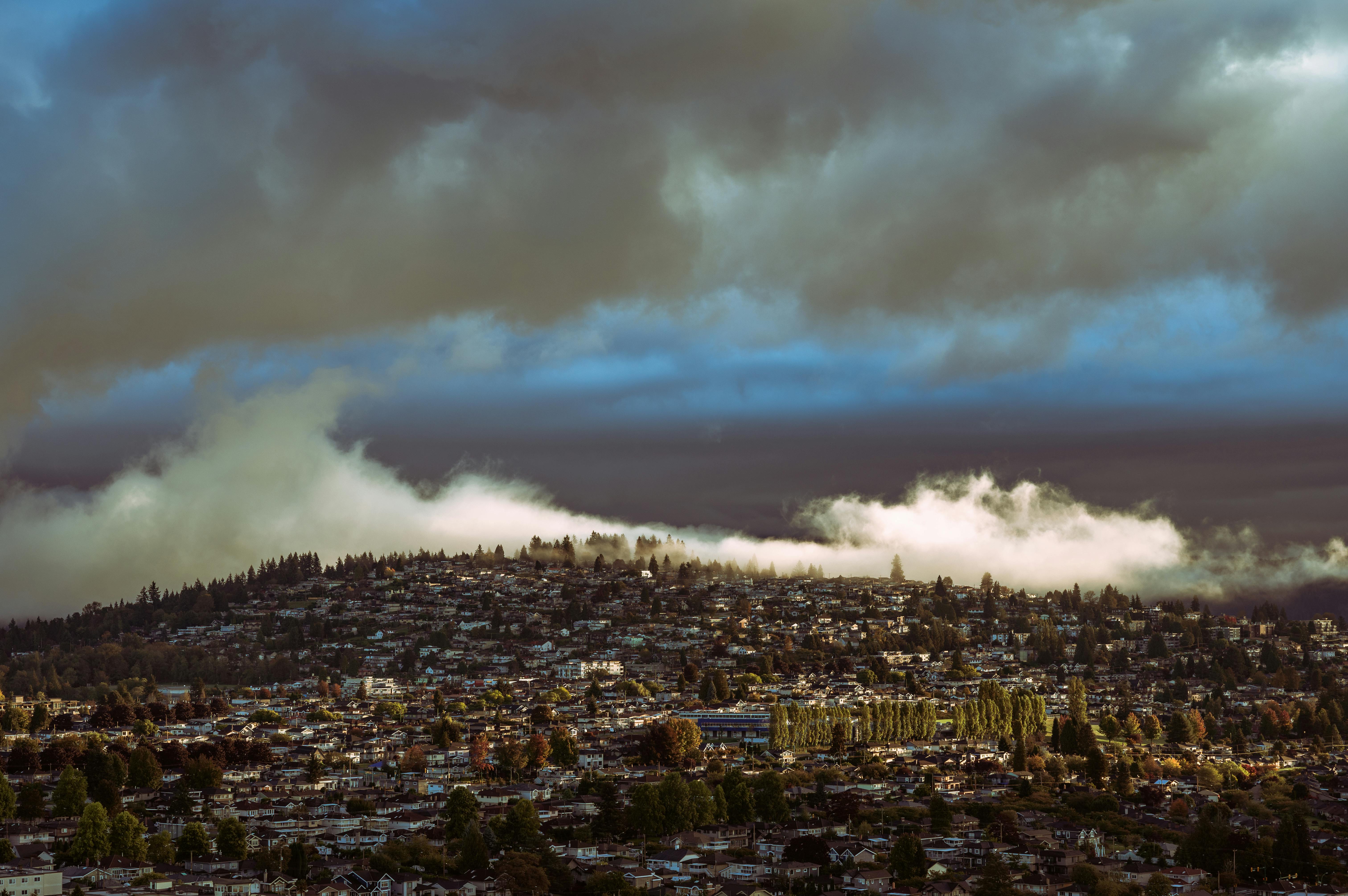 Aerial Shot of a City Under the Cloudy Sky · Free Stock Photo