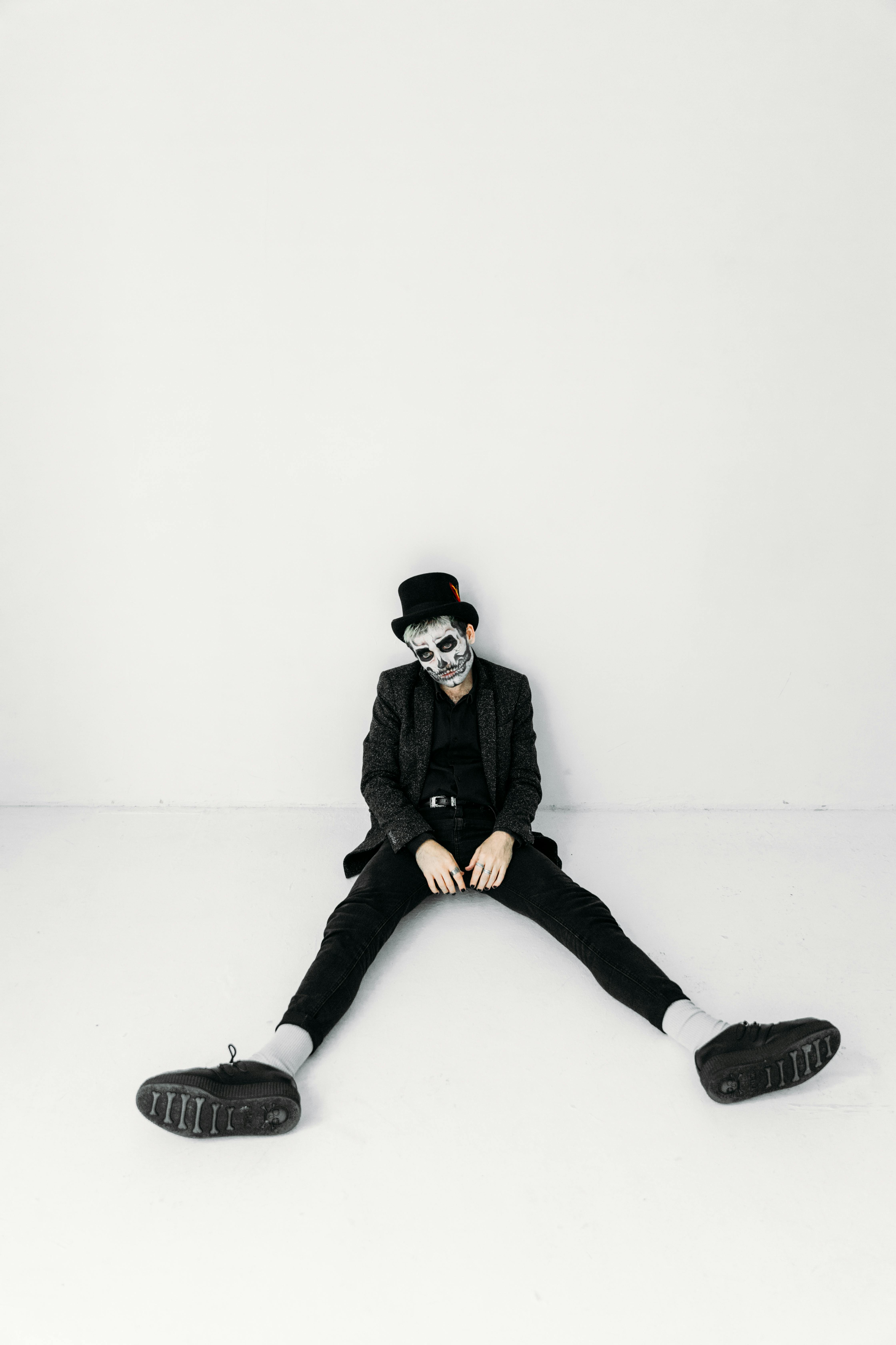 Man in Black Jacket and Black Pants Sitting on Floor · Free Stock Photo