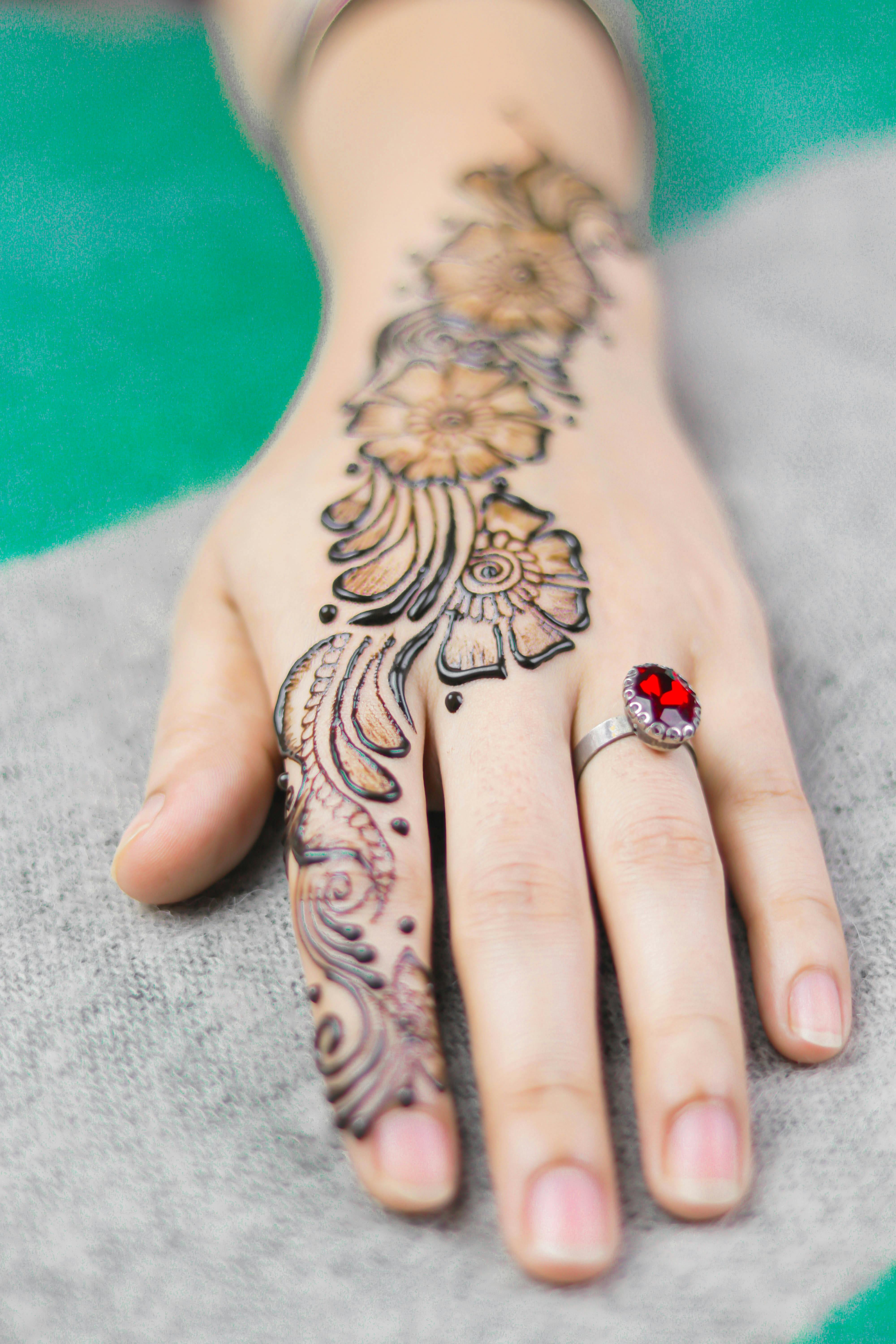 A Person Wearing a Ruby Ring · Free Stock Photo