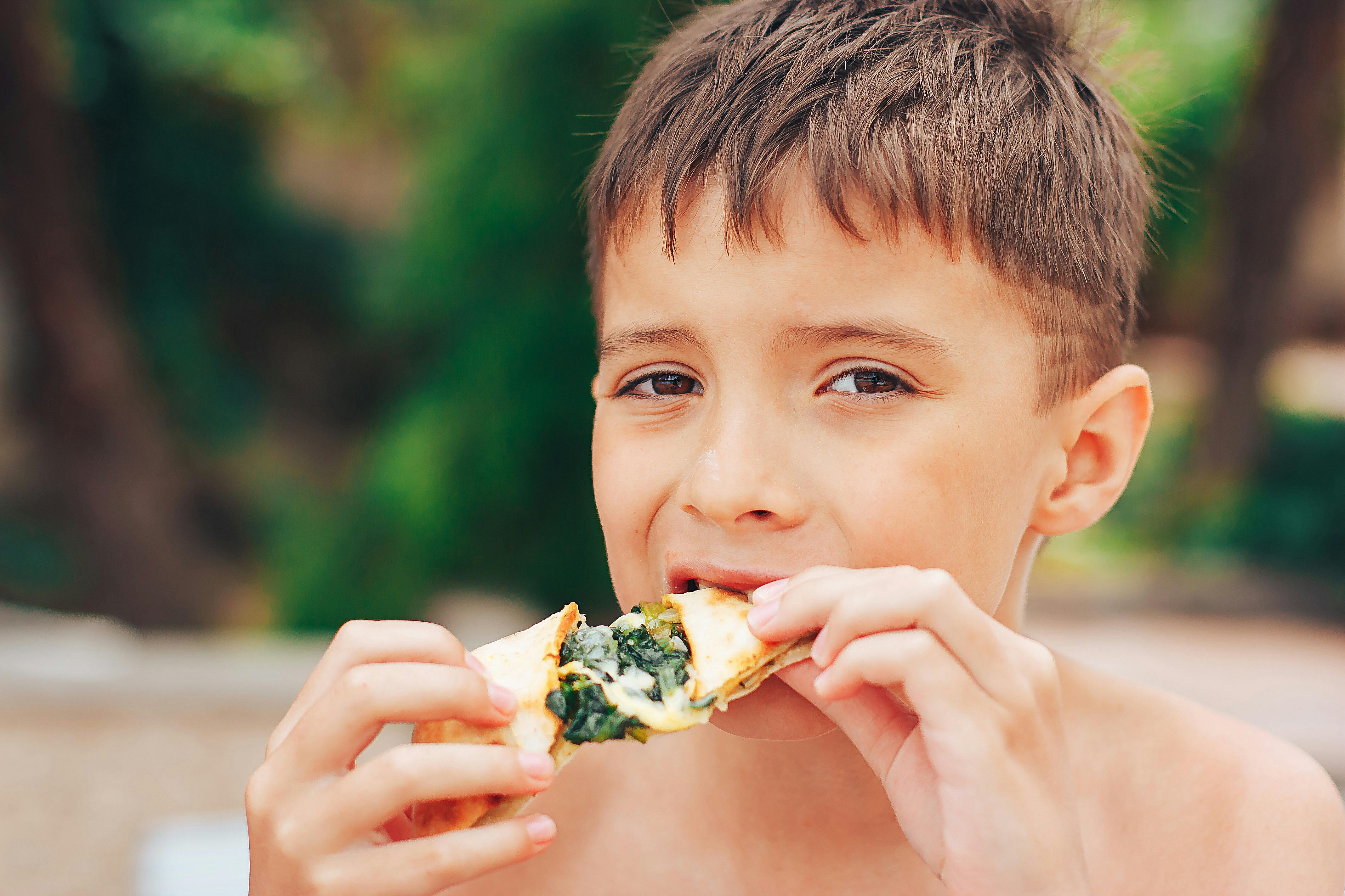 Portrait of a Boy Eating · Free Stock Photo
