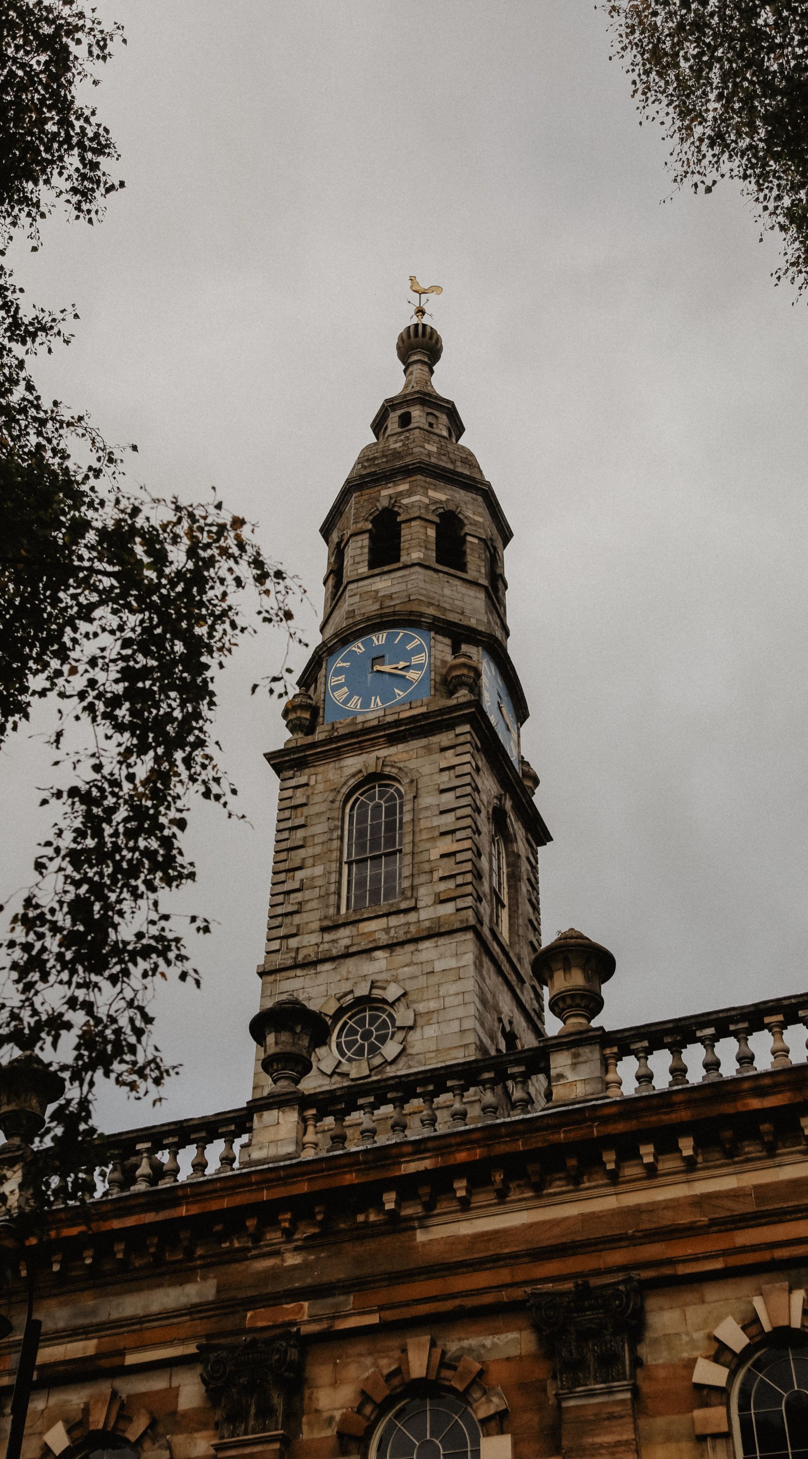 A Brown Clock Tower Under Gray Sky · Free Stock Photo