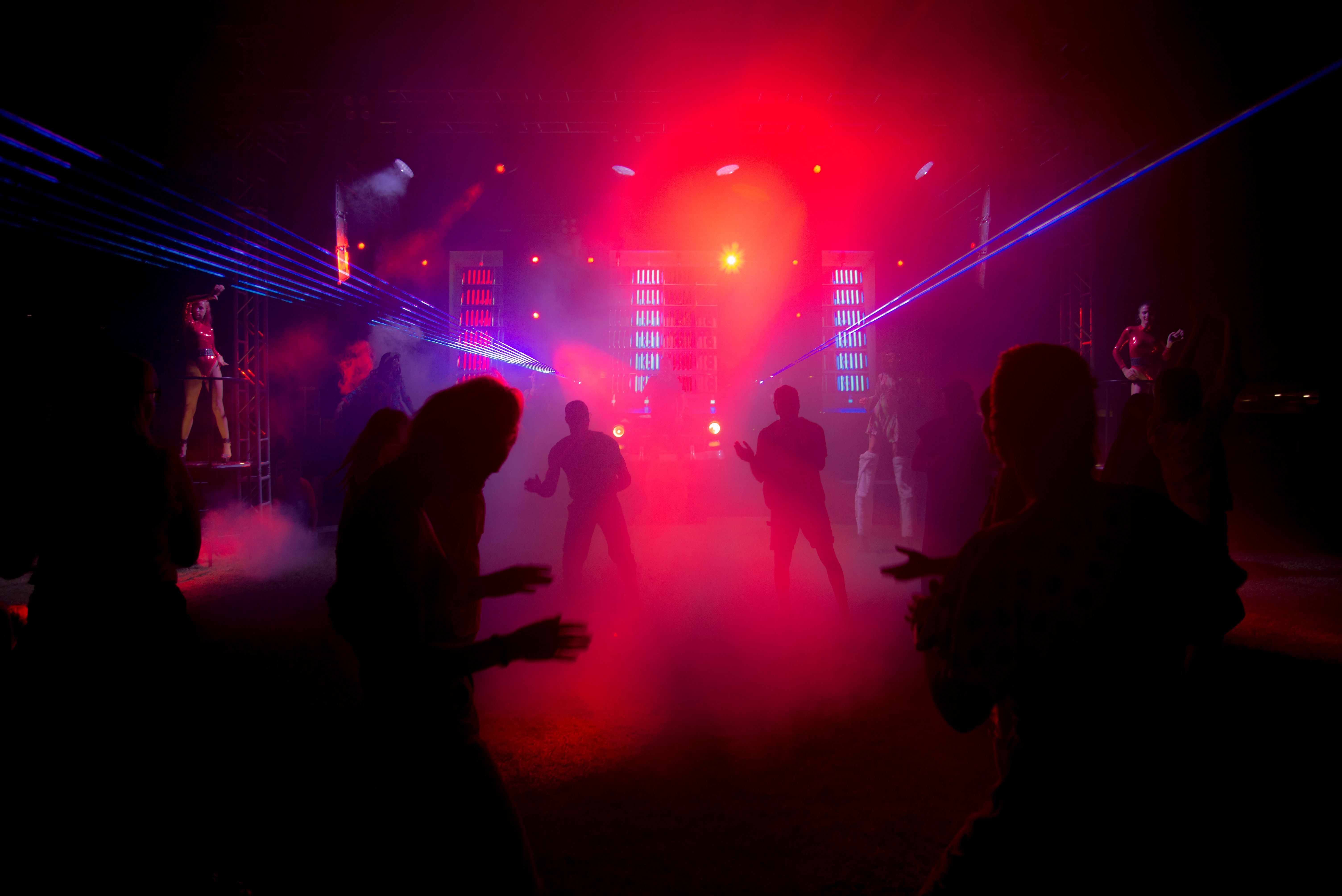 A Person Standing on Stage Standing Against the Light · Free Stock Photo