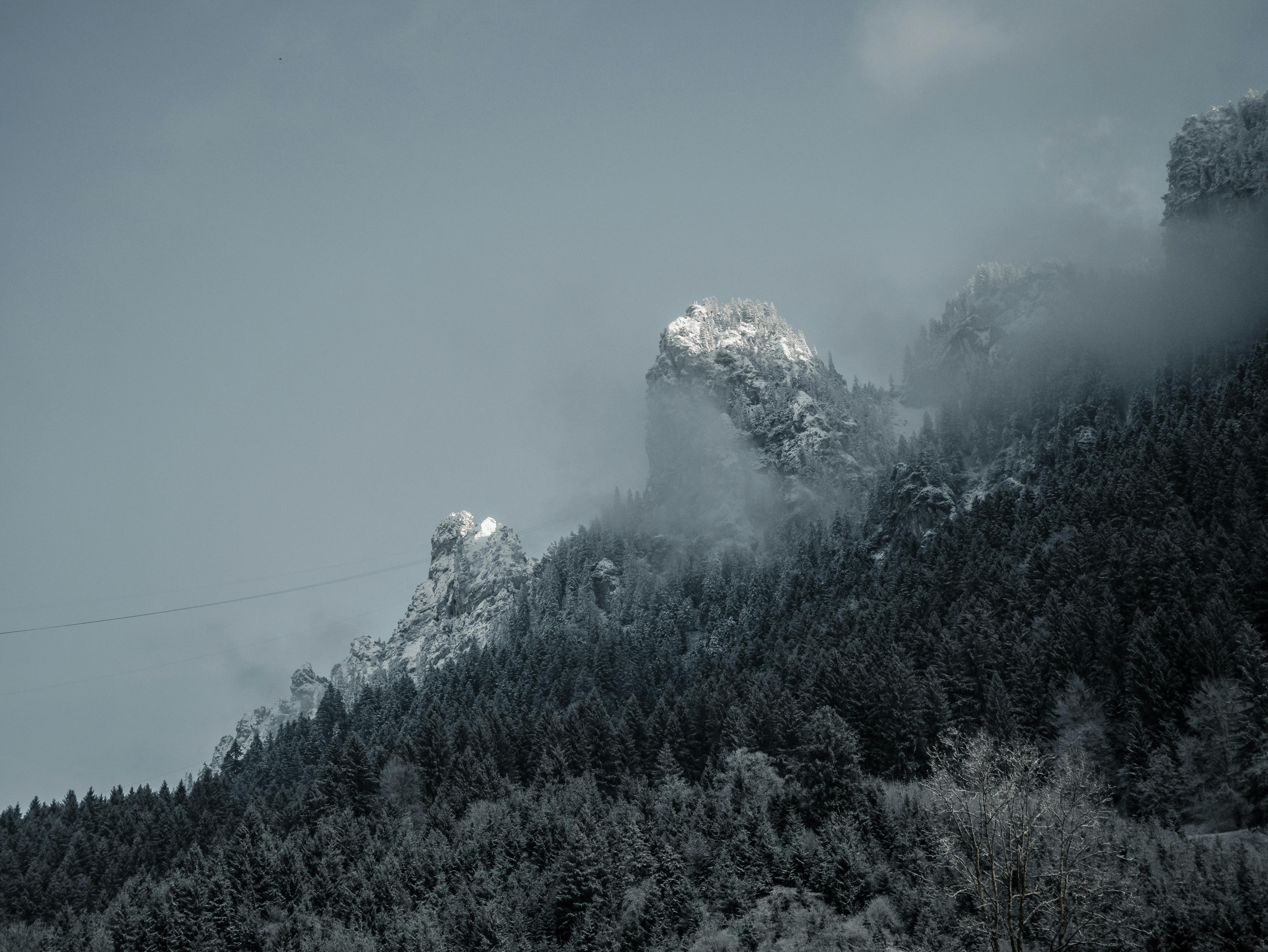 Snow Covered Mountain Under Foggy Sky · Free Stock Photo