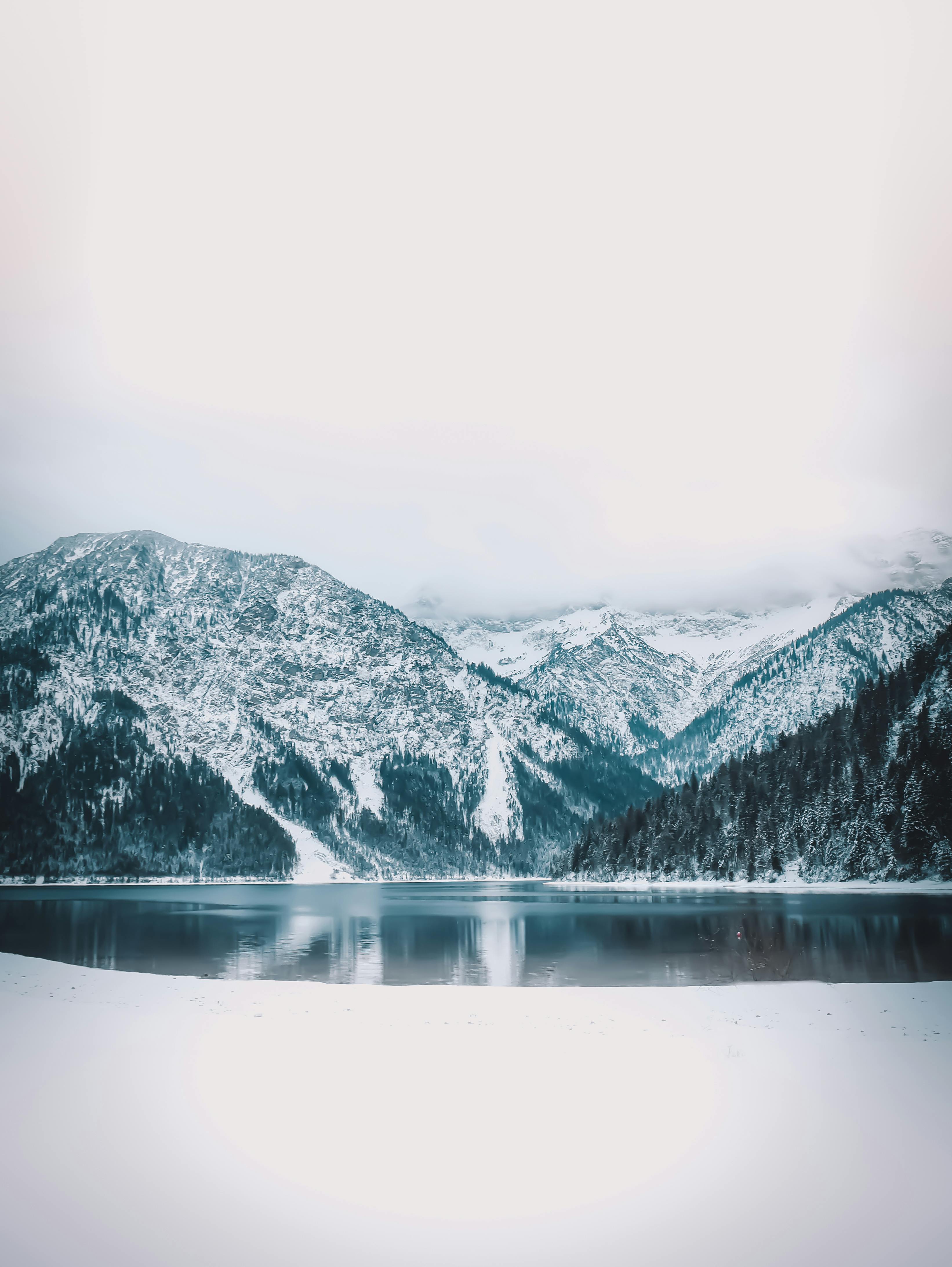 Snow Covered Mountain Under Gray Sky · Free Stock Photo