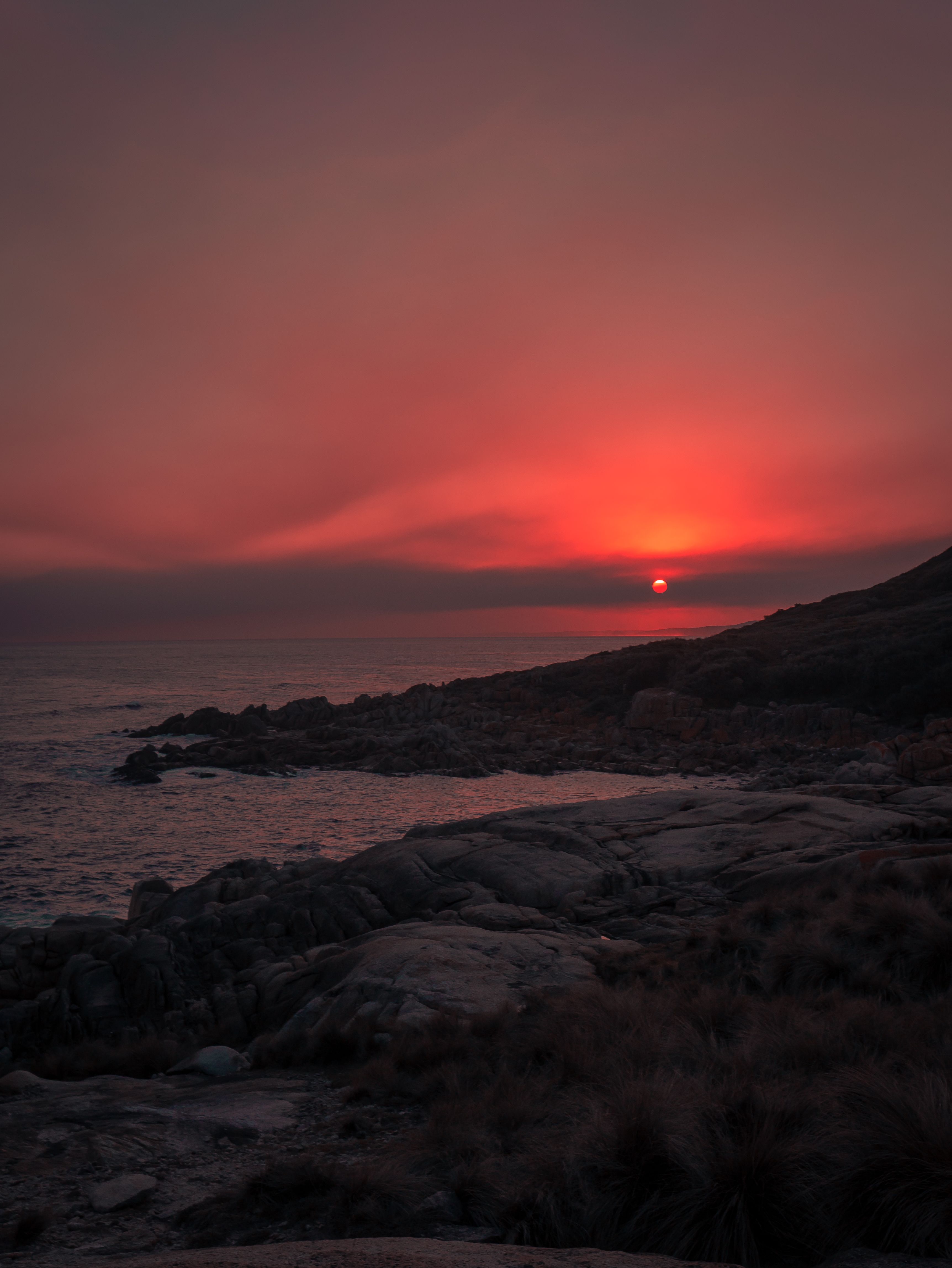 Black Rock Formation Near Body of Water during Sunset · Free Stock Photo
