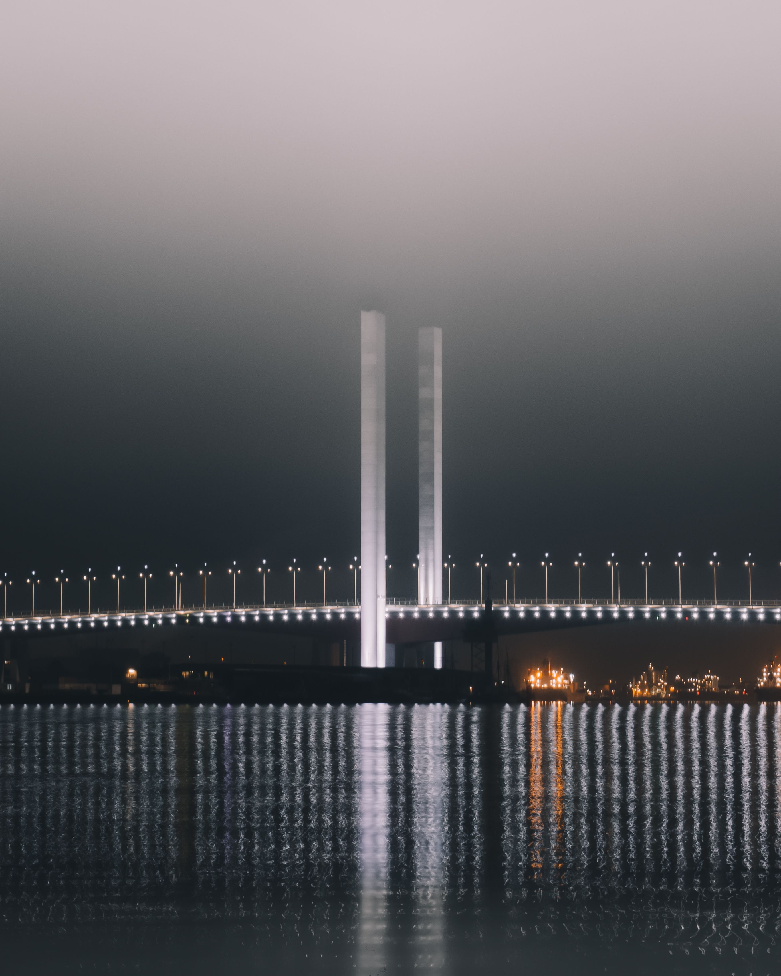 Lighted Bridge over River in the City During Night Time · Free Stock Photo