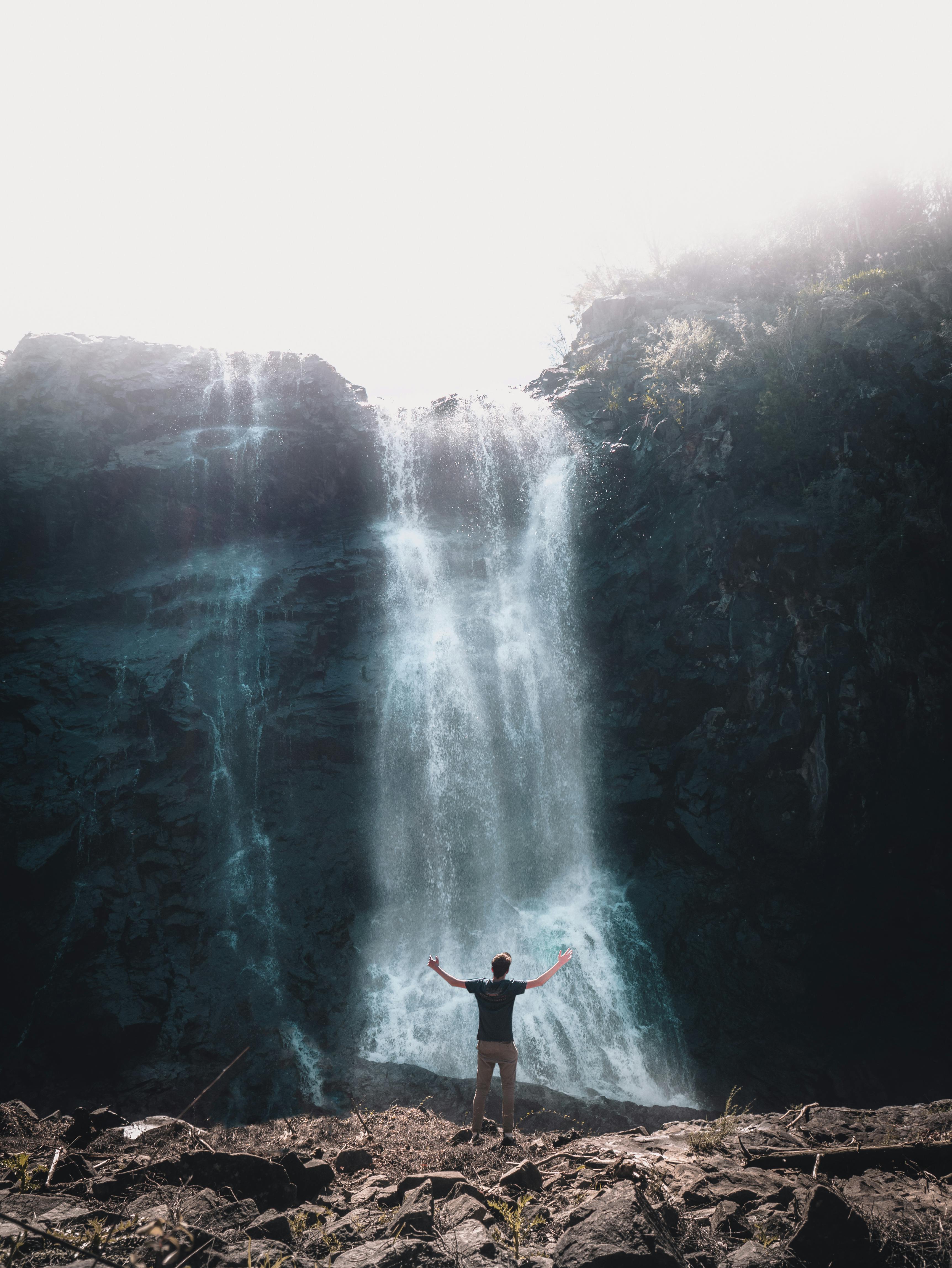 A Person Standing by a Waterfall · Free Stock Photo
