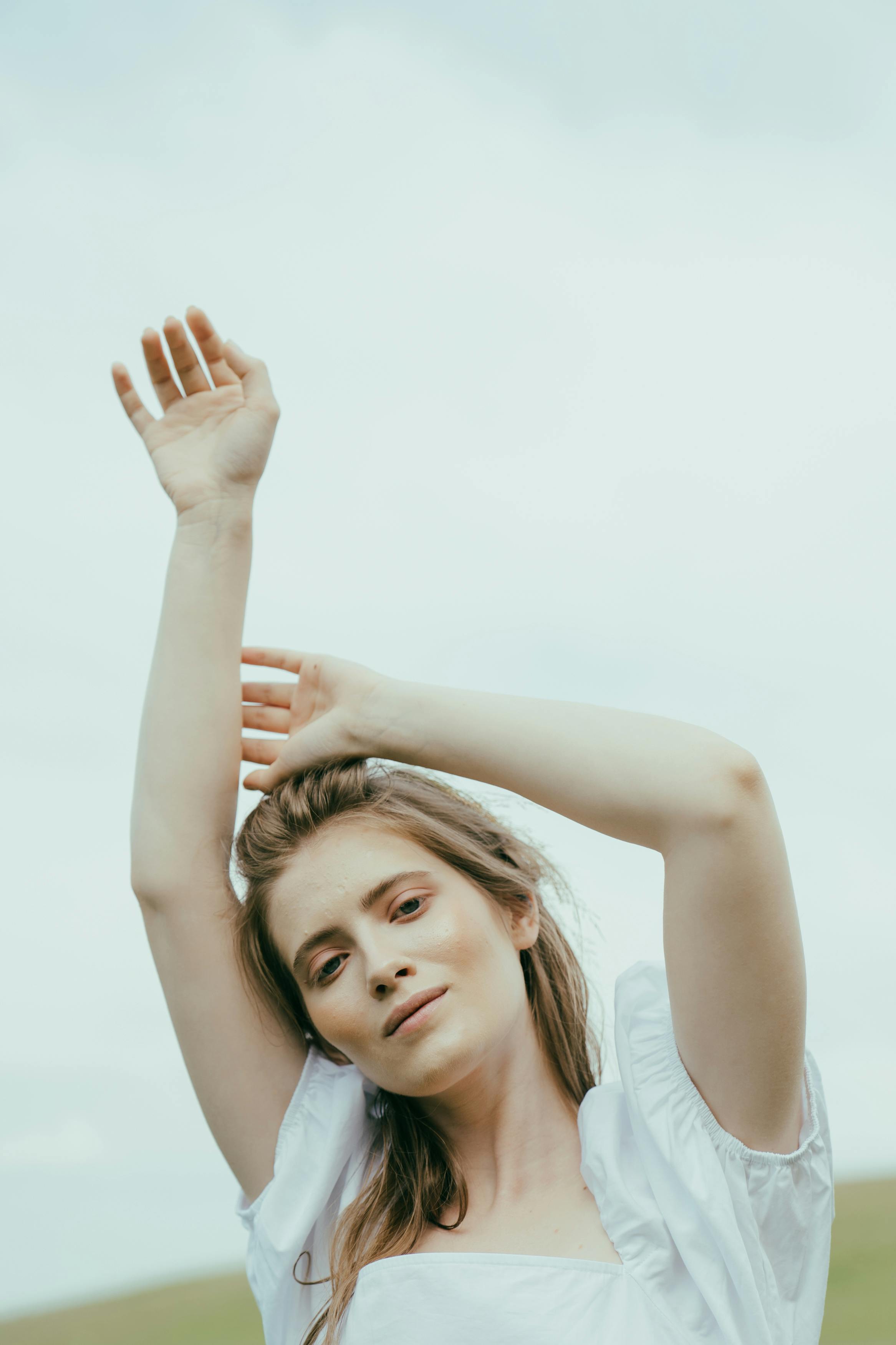 Woman Posing with Her Arm Raised · Free Stock Photo
