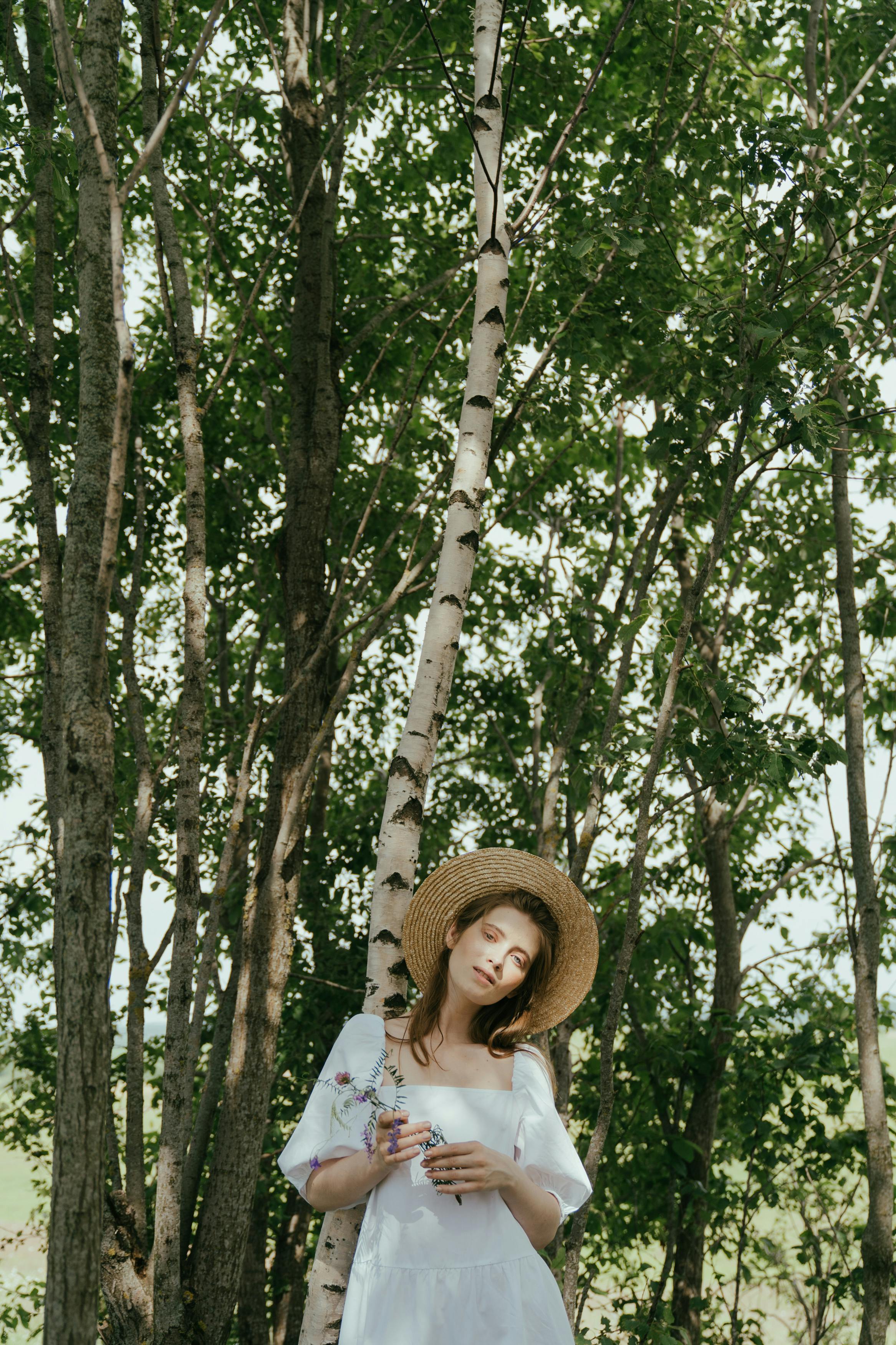 A Woman Standing Beside the Trees · Free Stock Photo