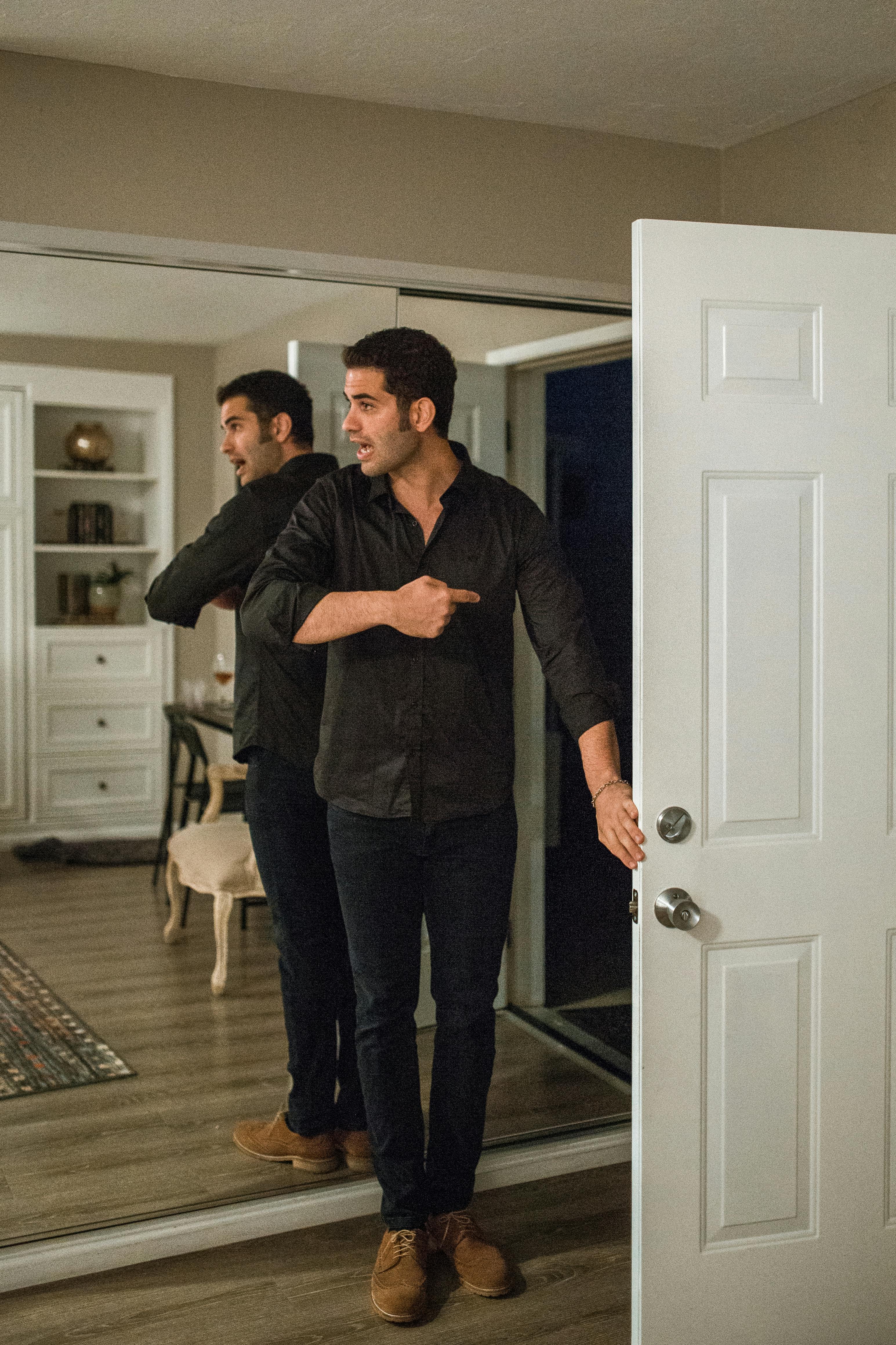 Man Standing by Door and Arguing · Free Stock Photo