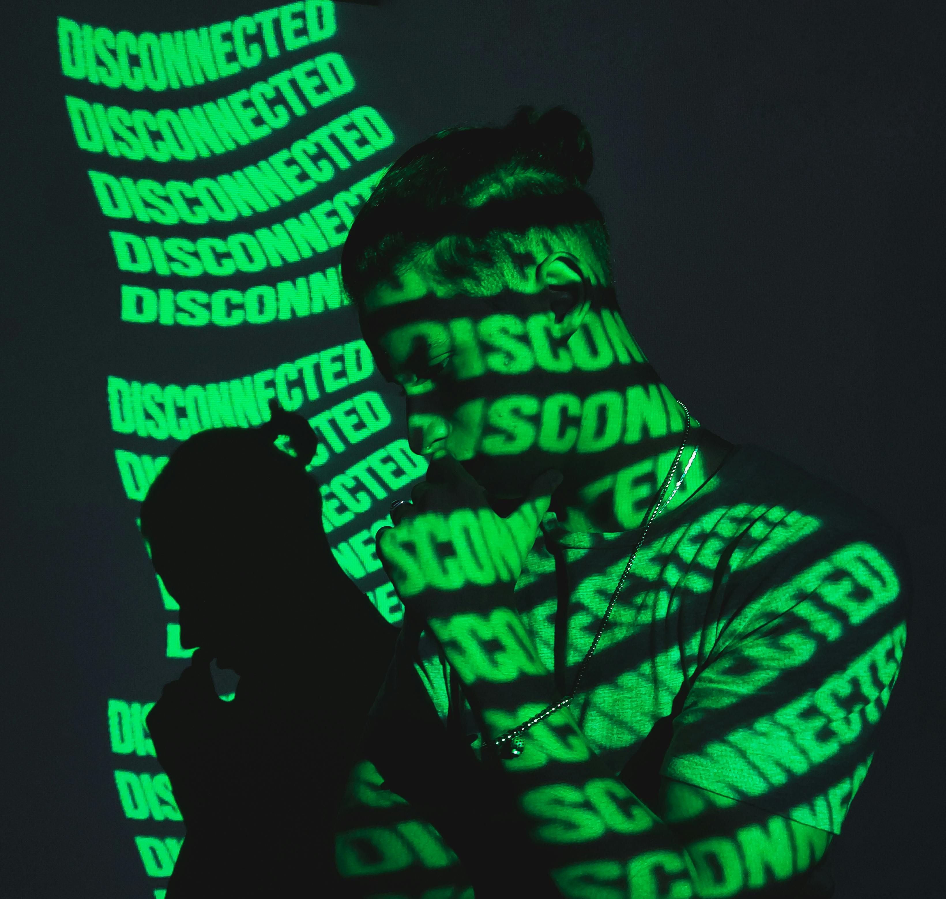 Man Standing in the Light of a Projector · Free Stock Photo