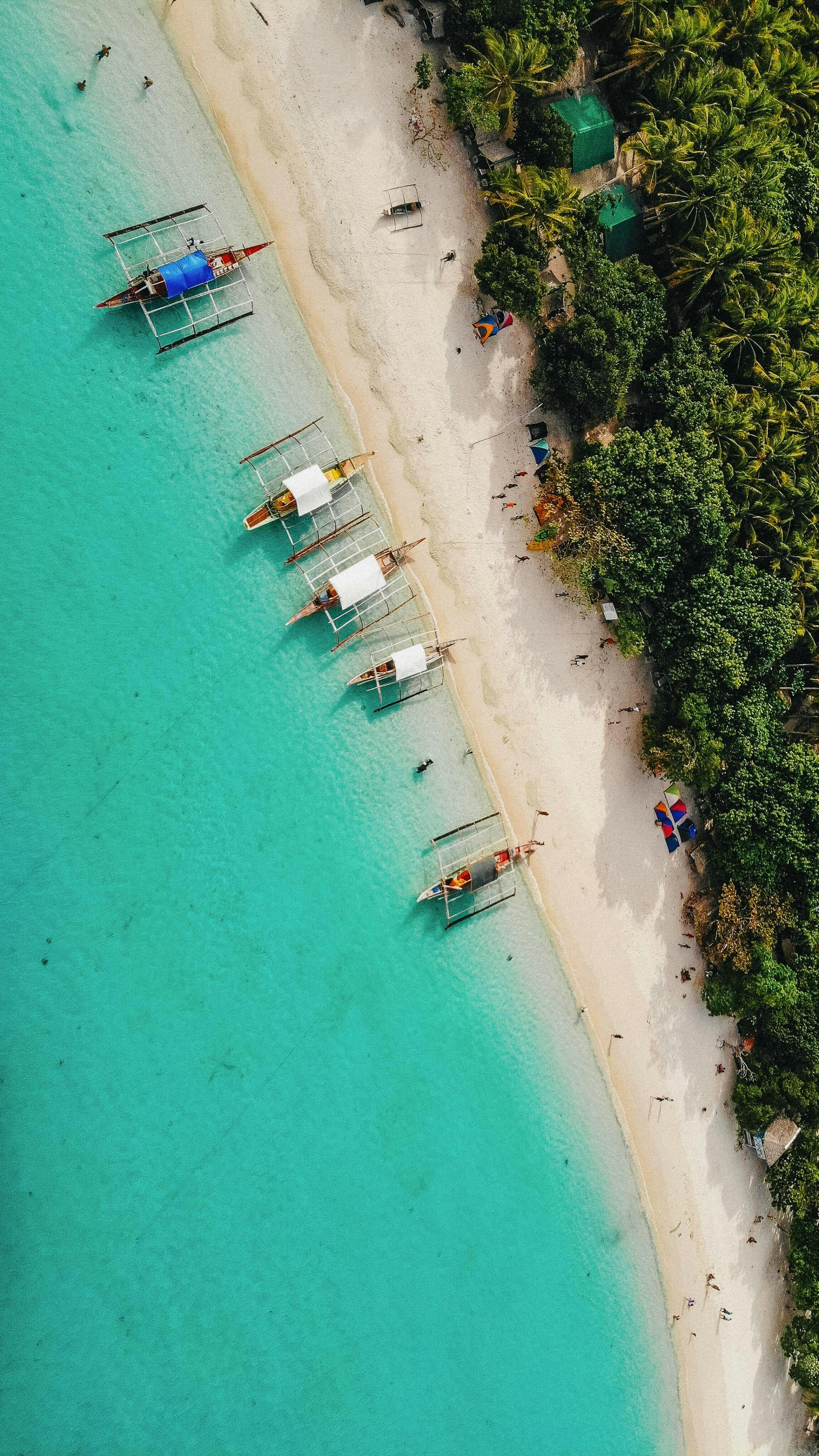 An Aerial Photography of a Beach with Boats on the Seashore · Free ...