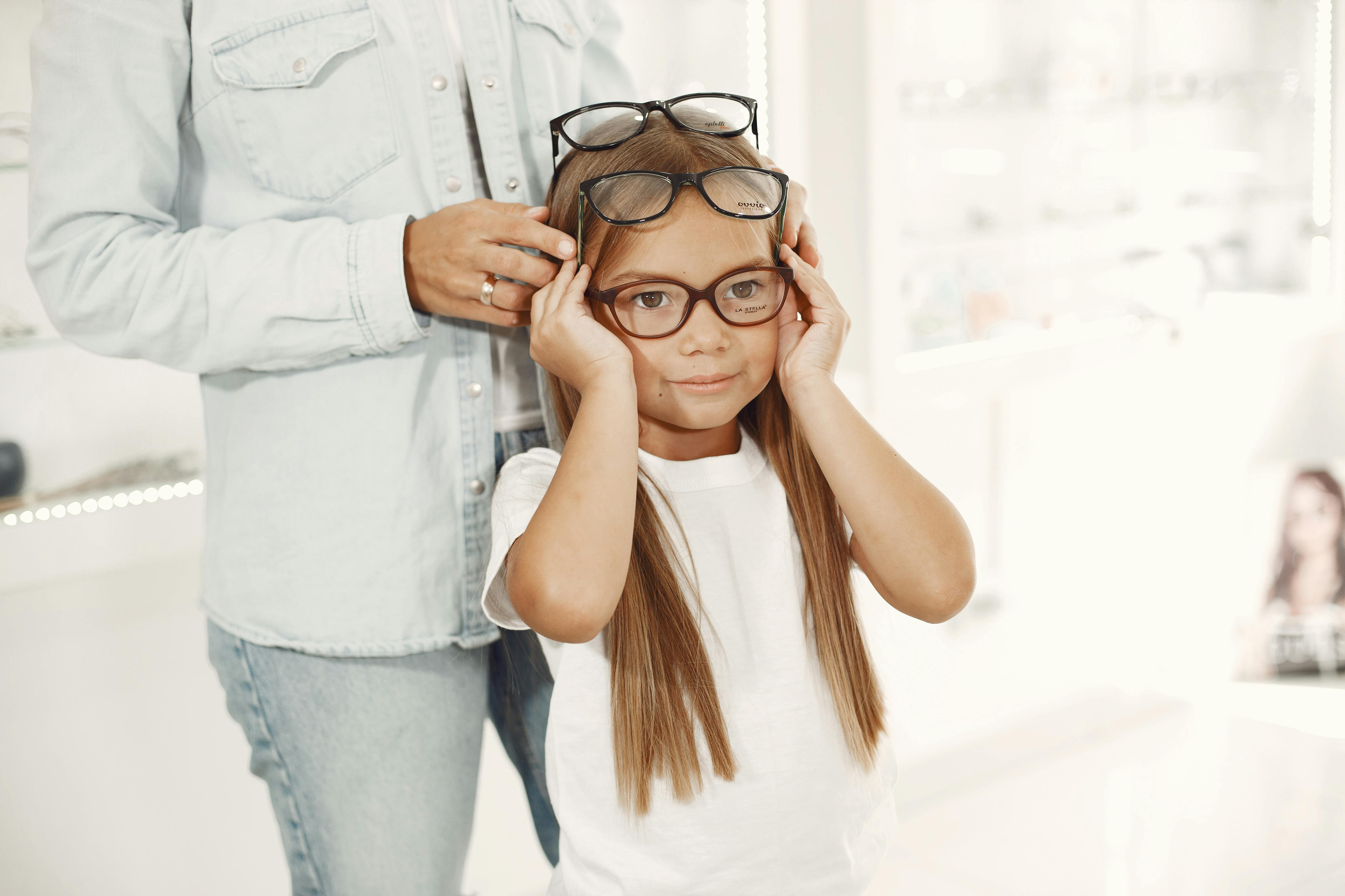 A Young Girl Wearing Different Eyeglasses · Free Stock Photo