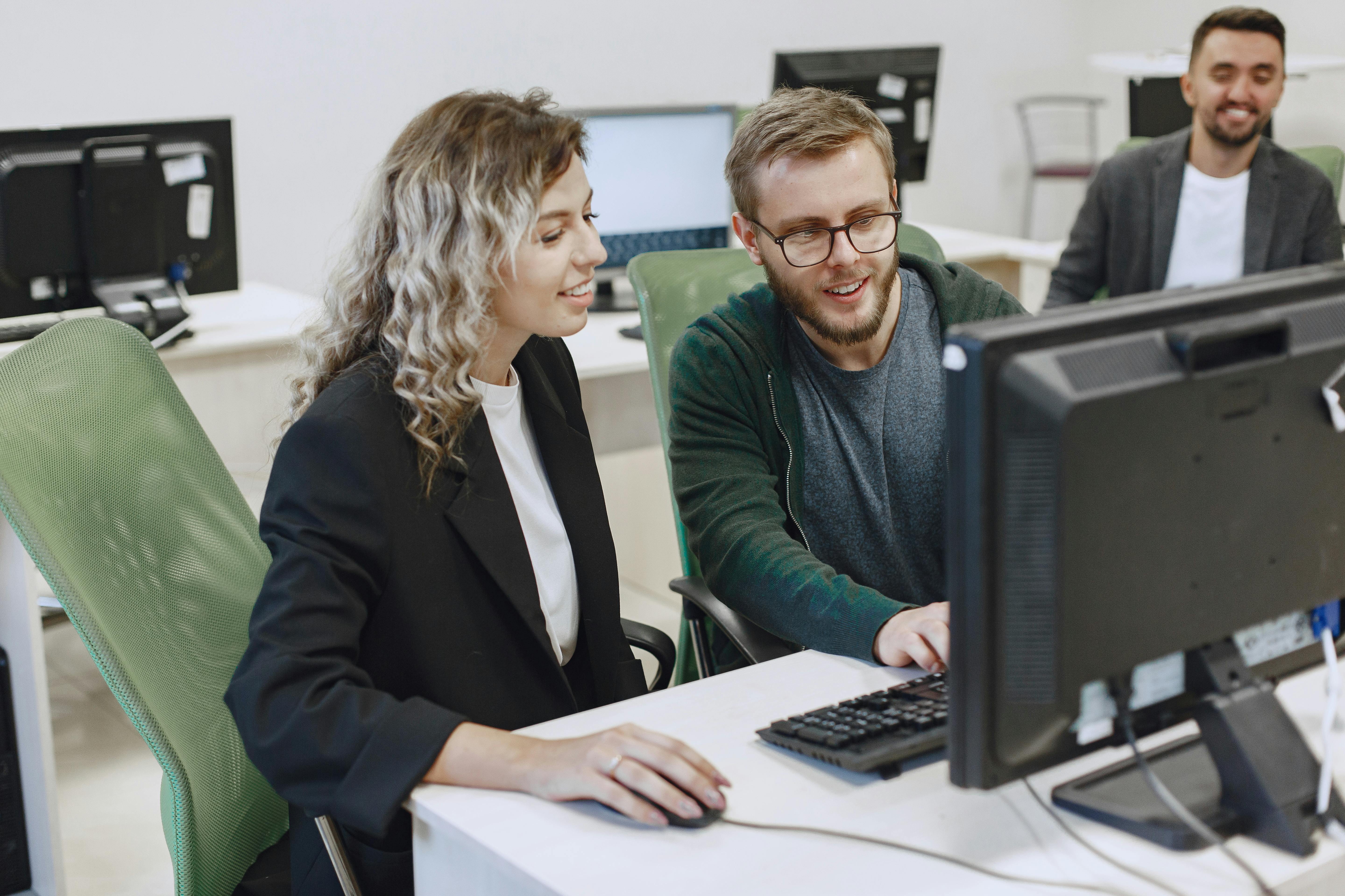 A Group of People in a Computer Lab Laughing · Free Stock Photo