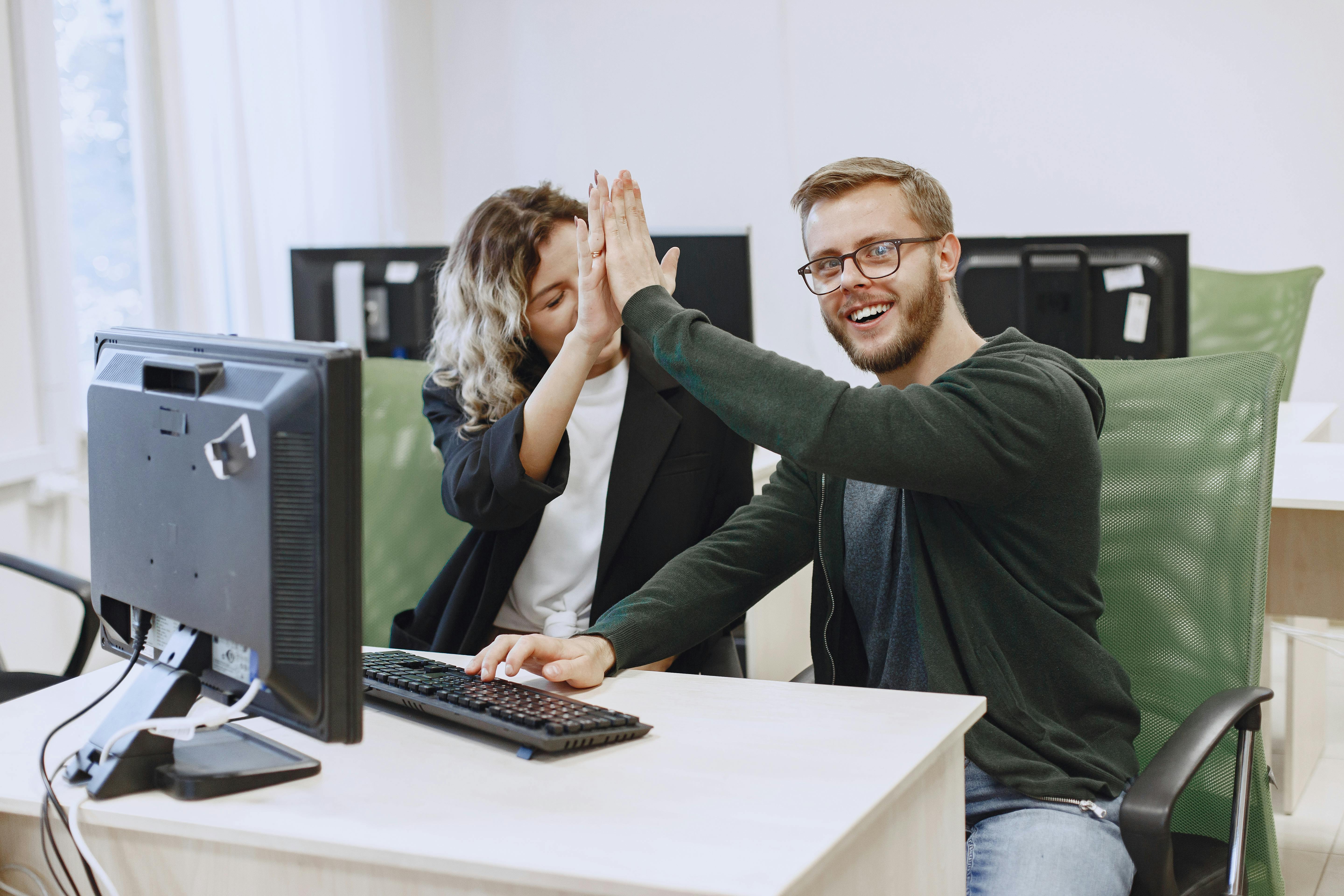 A Man and Woman Doing High Five · Free Stock Photo