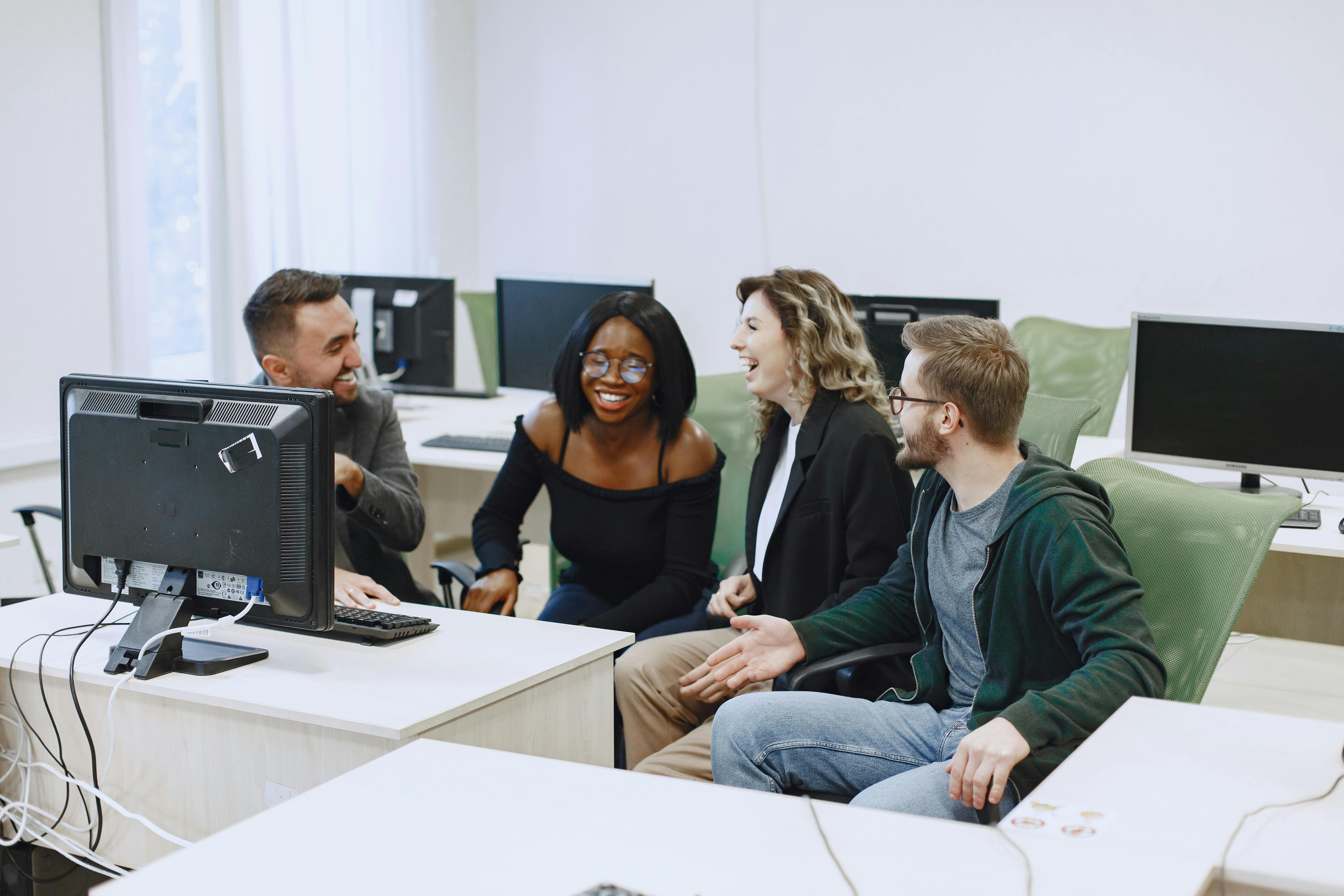 A Group of People in a Computer Lab Laughing · Free Stock Photo