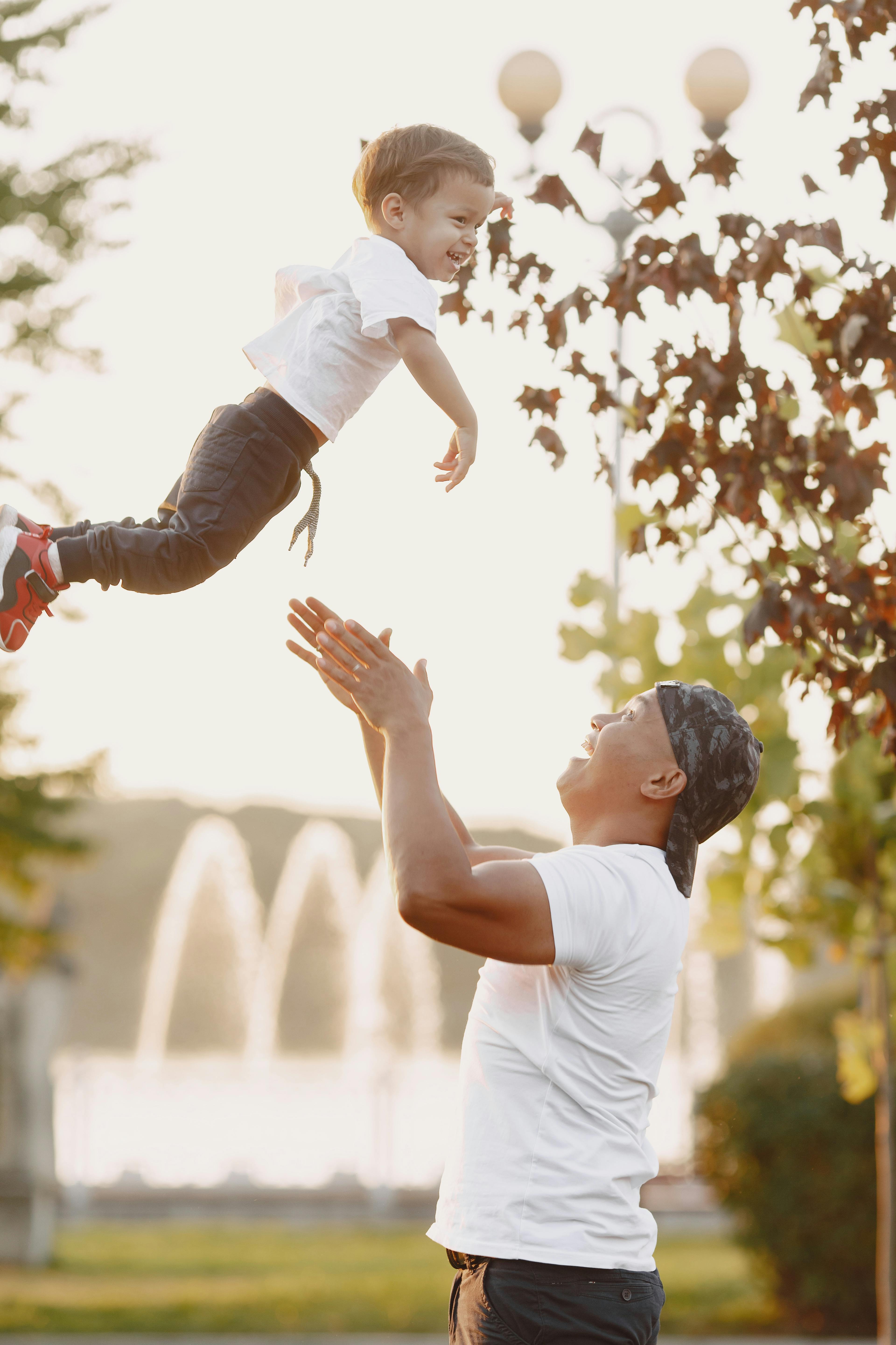 A Father Throwing His Son in the Air · Free Stock Photo