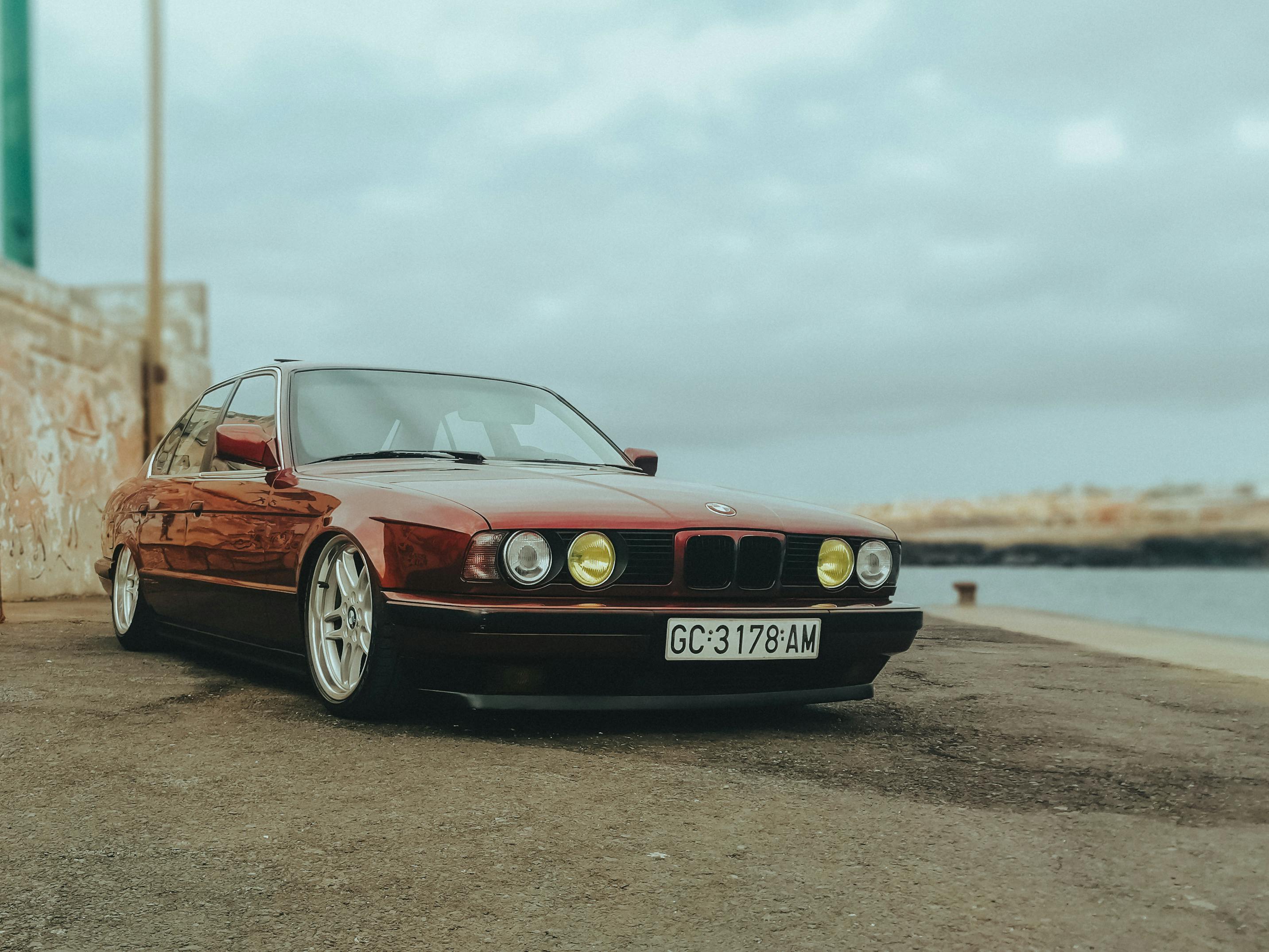 Red Bmw 5 Series Parked Near the Lake · Free Stock Photo