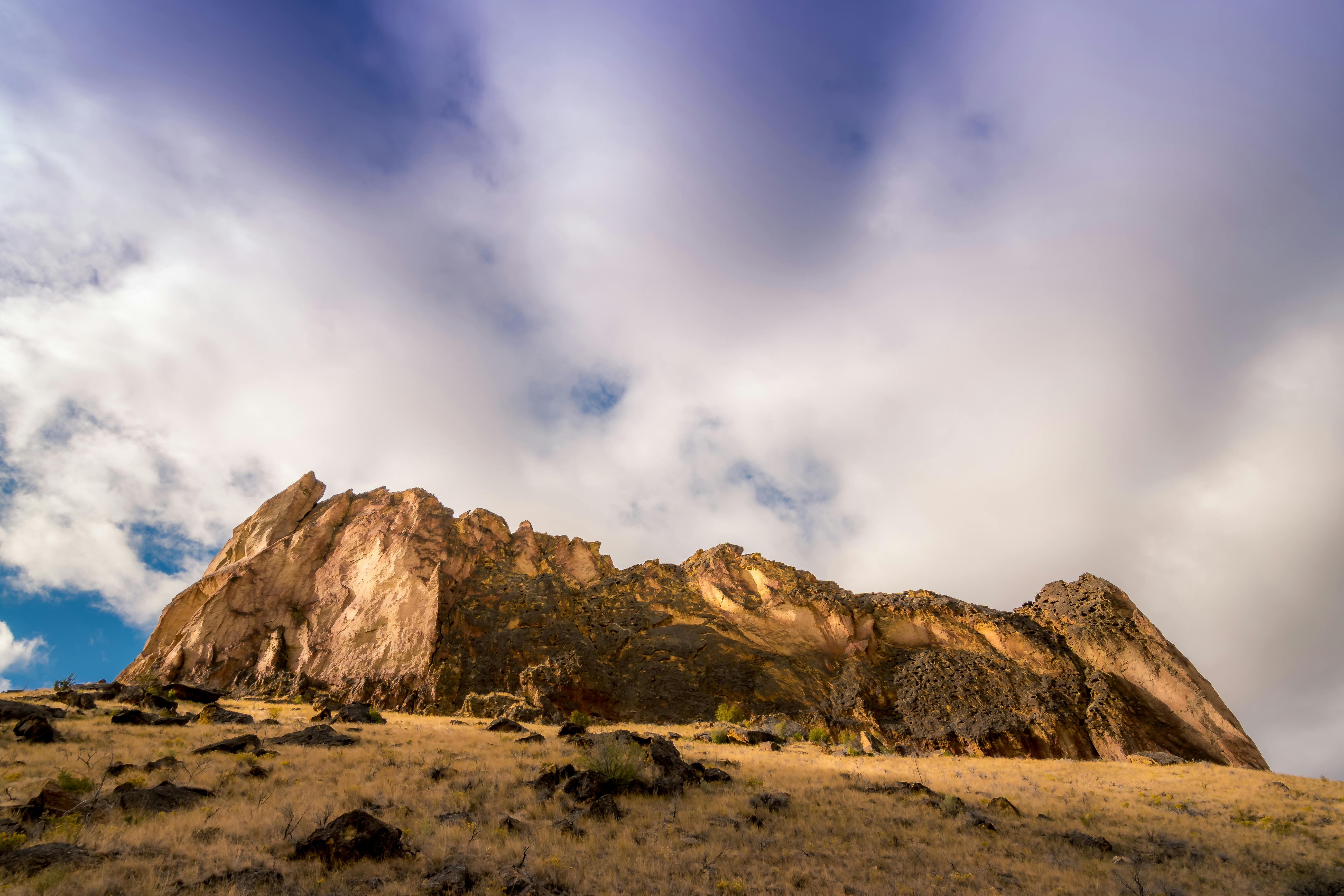 Rocky rough terrain on dried grass · Free Stock Photo